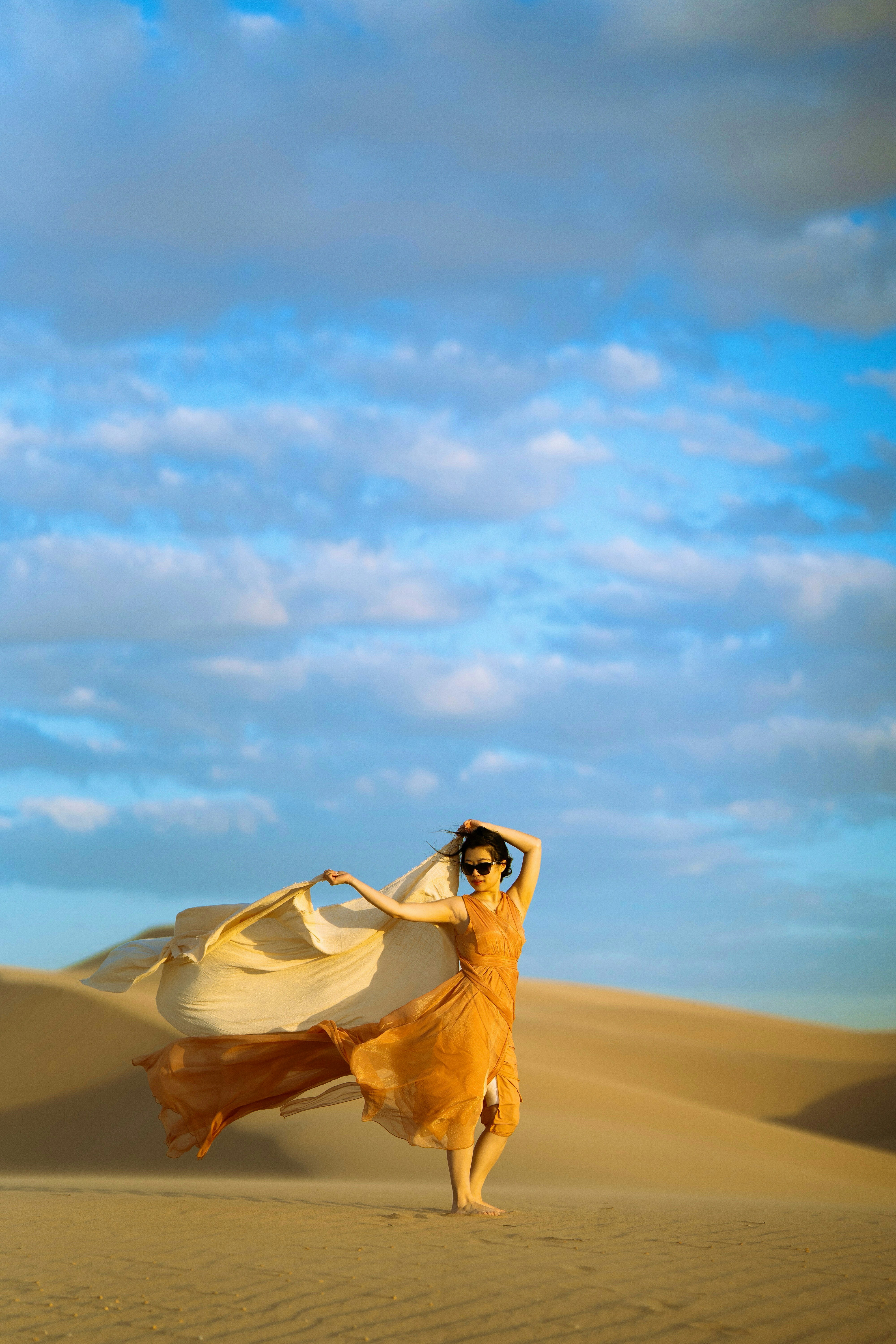 Model at Imperial Sand Dunes | Woman in flowing dress dancing in desert sand dunes