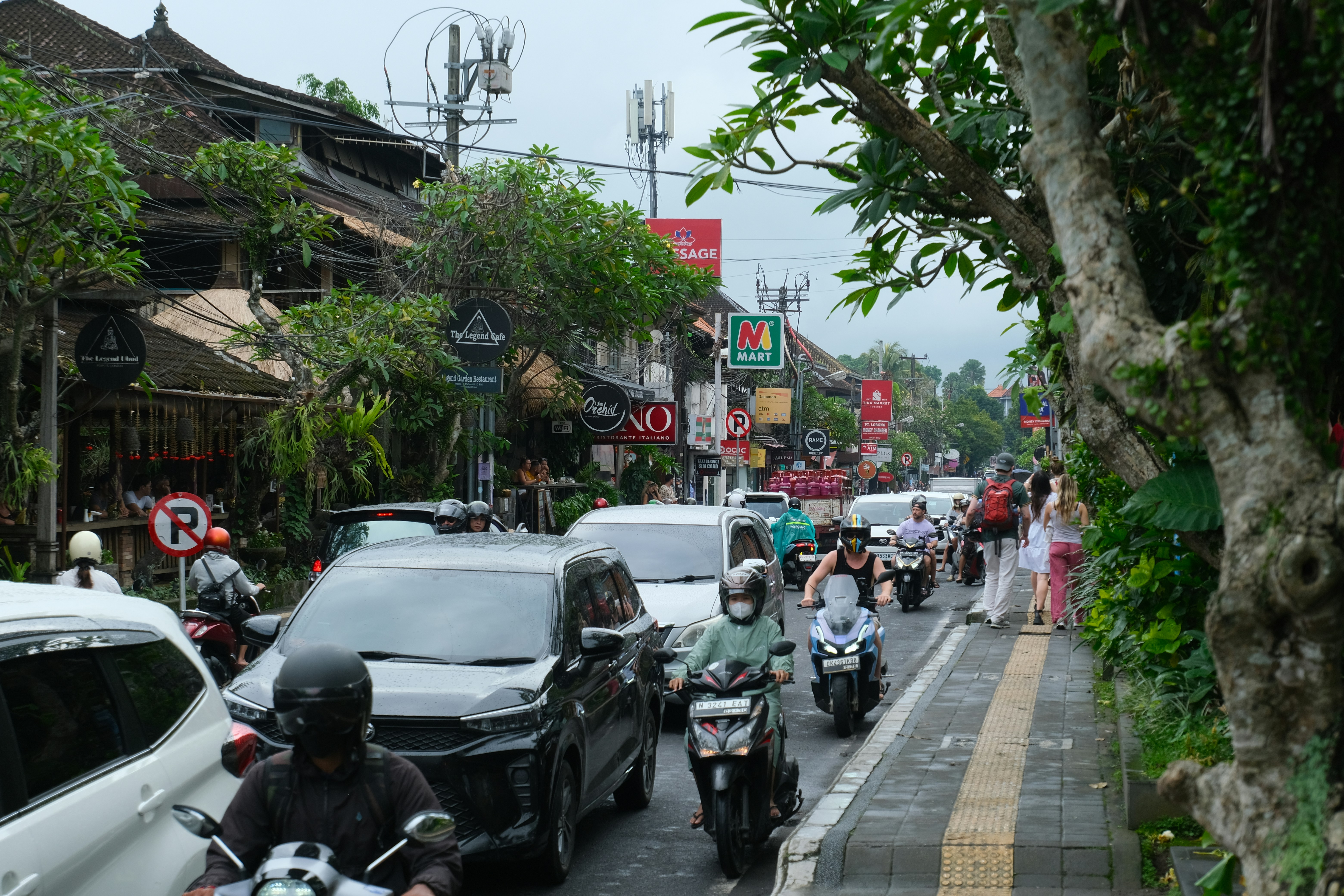 Traffic jam on a street with cars and motorcycles.