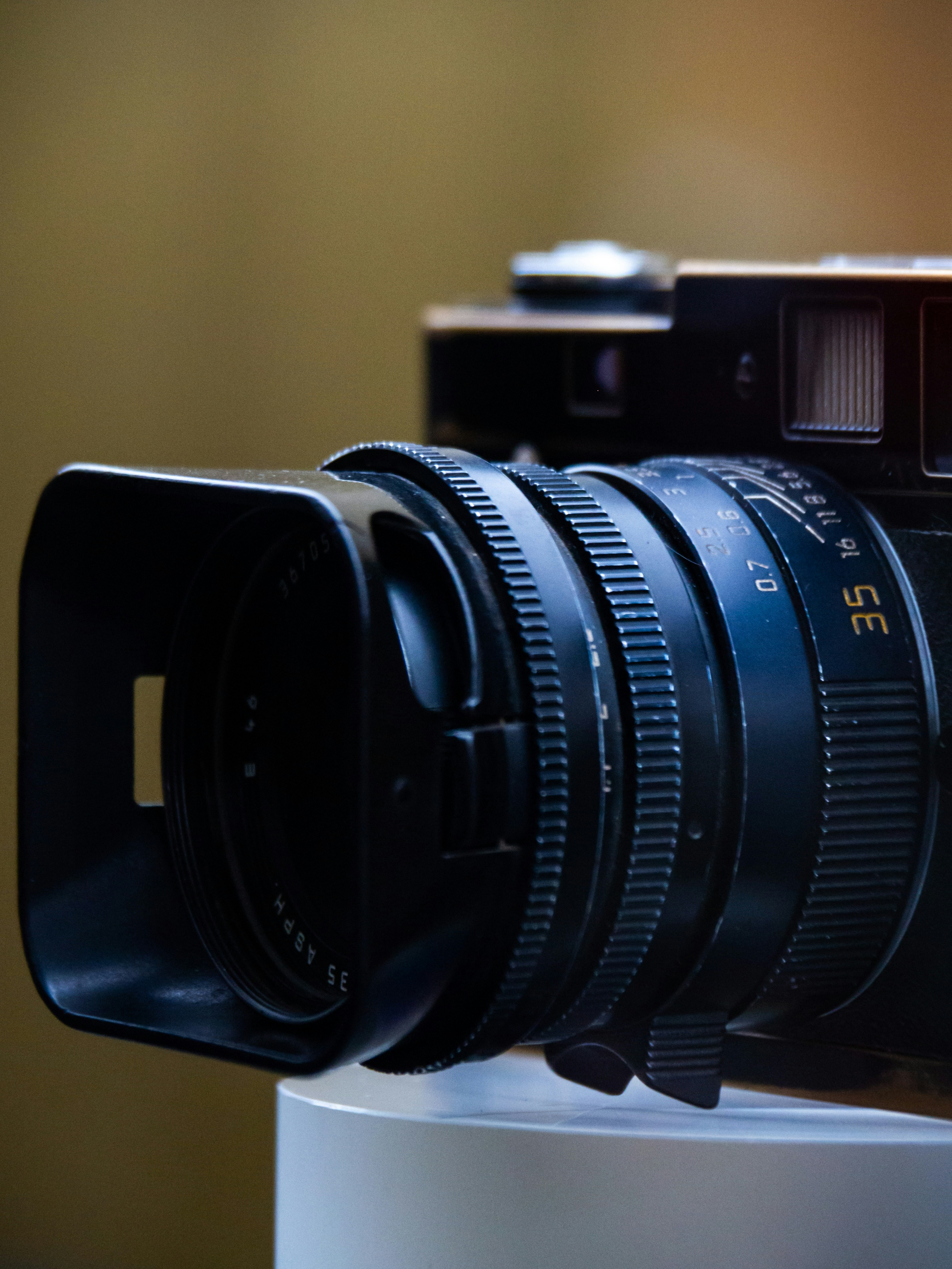 OLYMPUS DIGITAL CAMERA | Close-up of a black camera lens and body