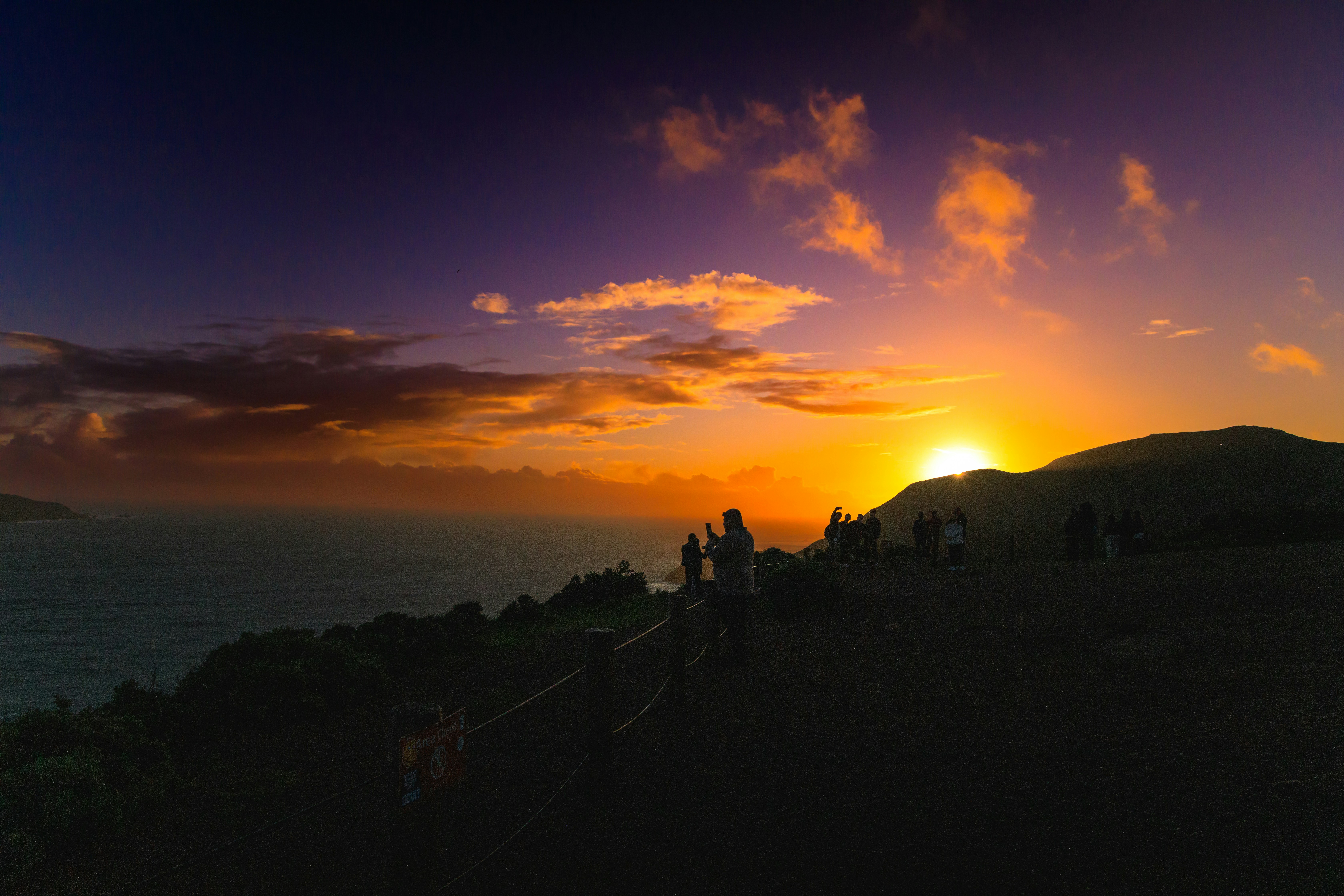 Dramatic sunset over a silhouetted mountain landscape