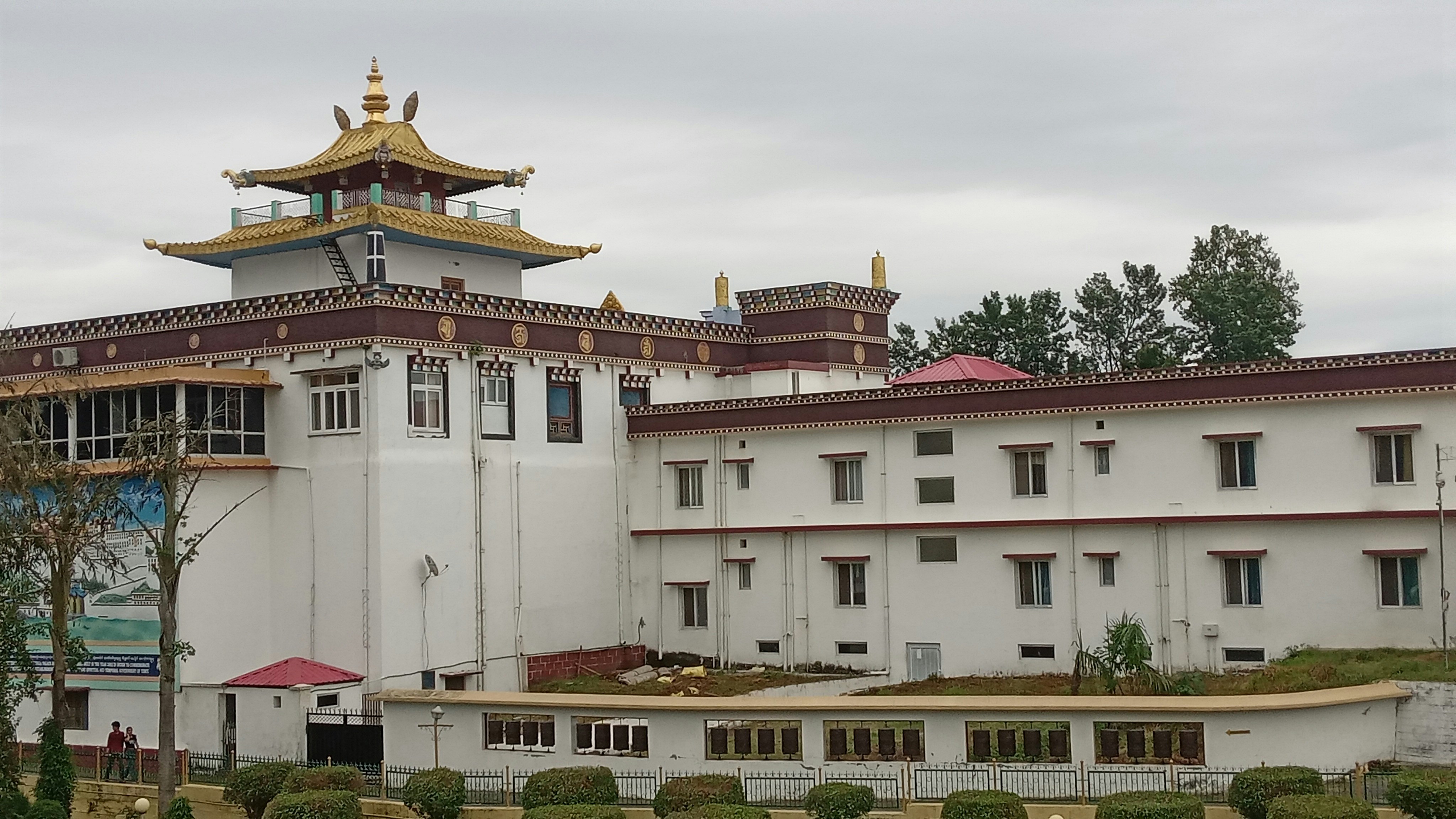 White building with ornate gold roof and windows