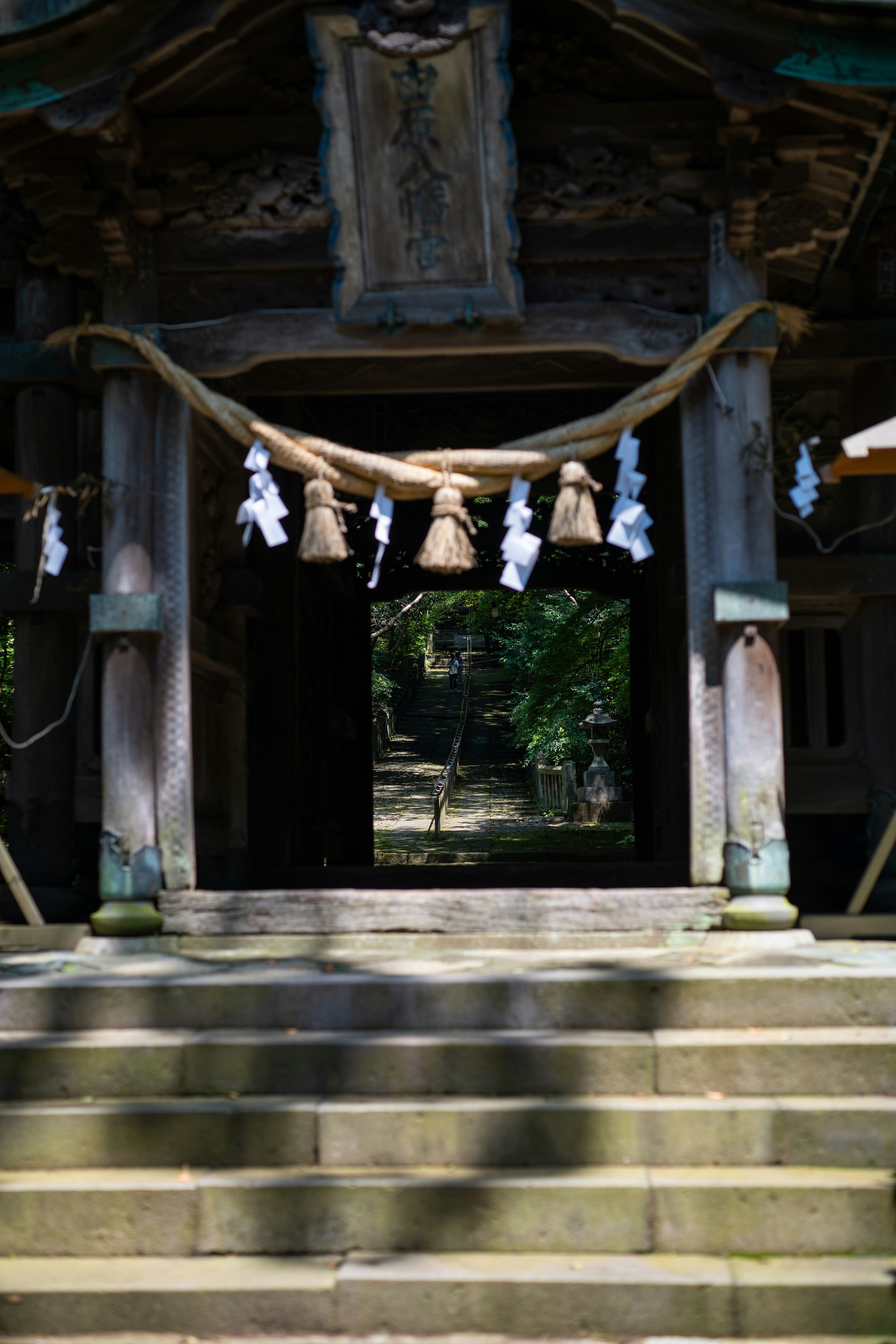 Entrance to a traditional japanese shrine with stone steps.