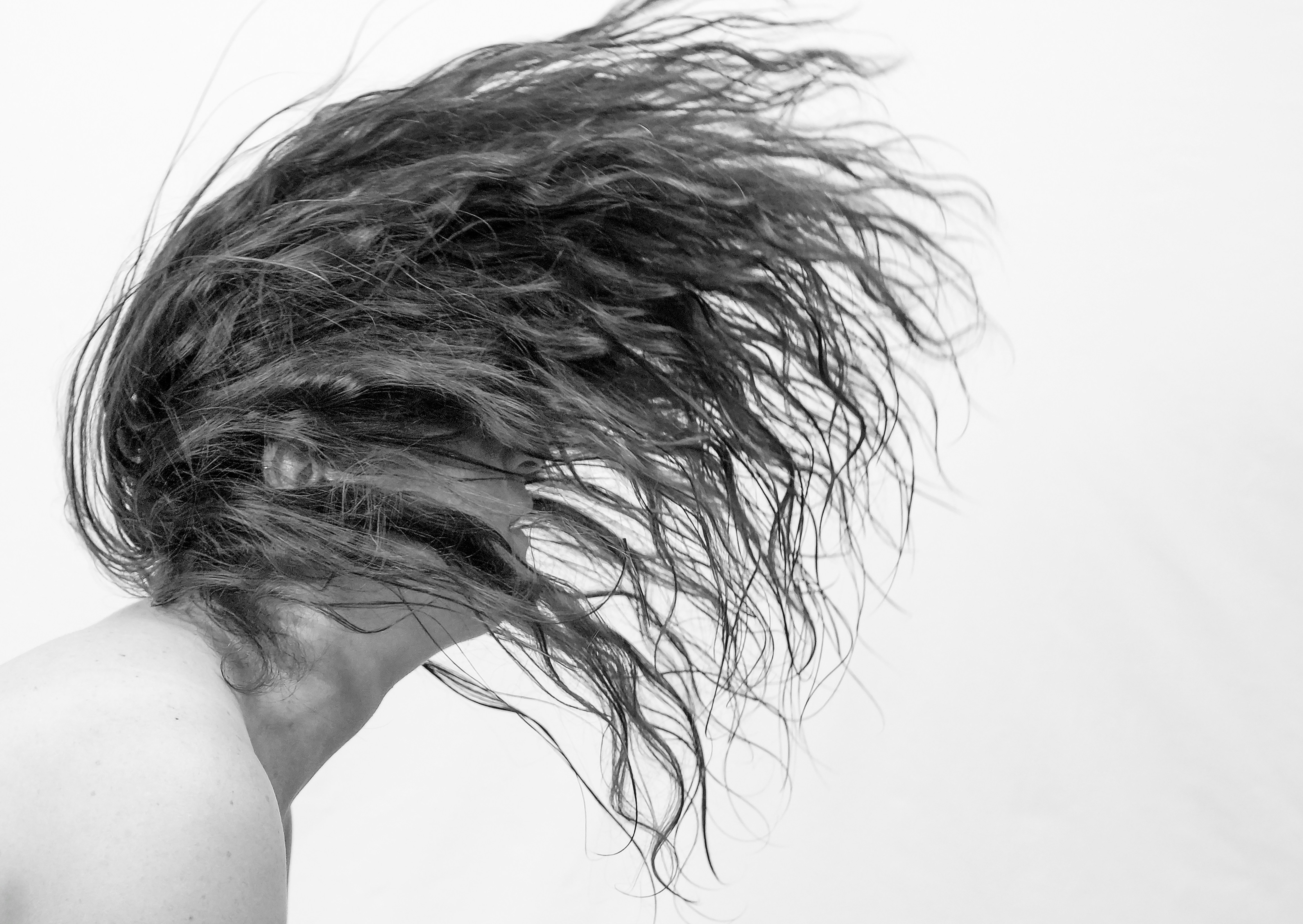 Woman's dark hair blowing in the wind