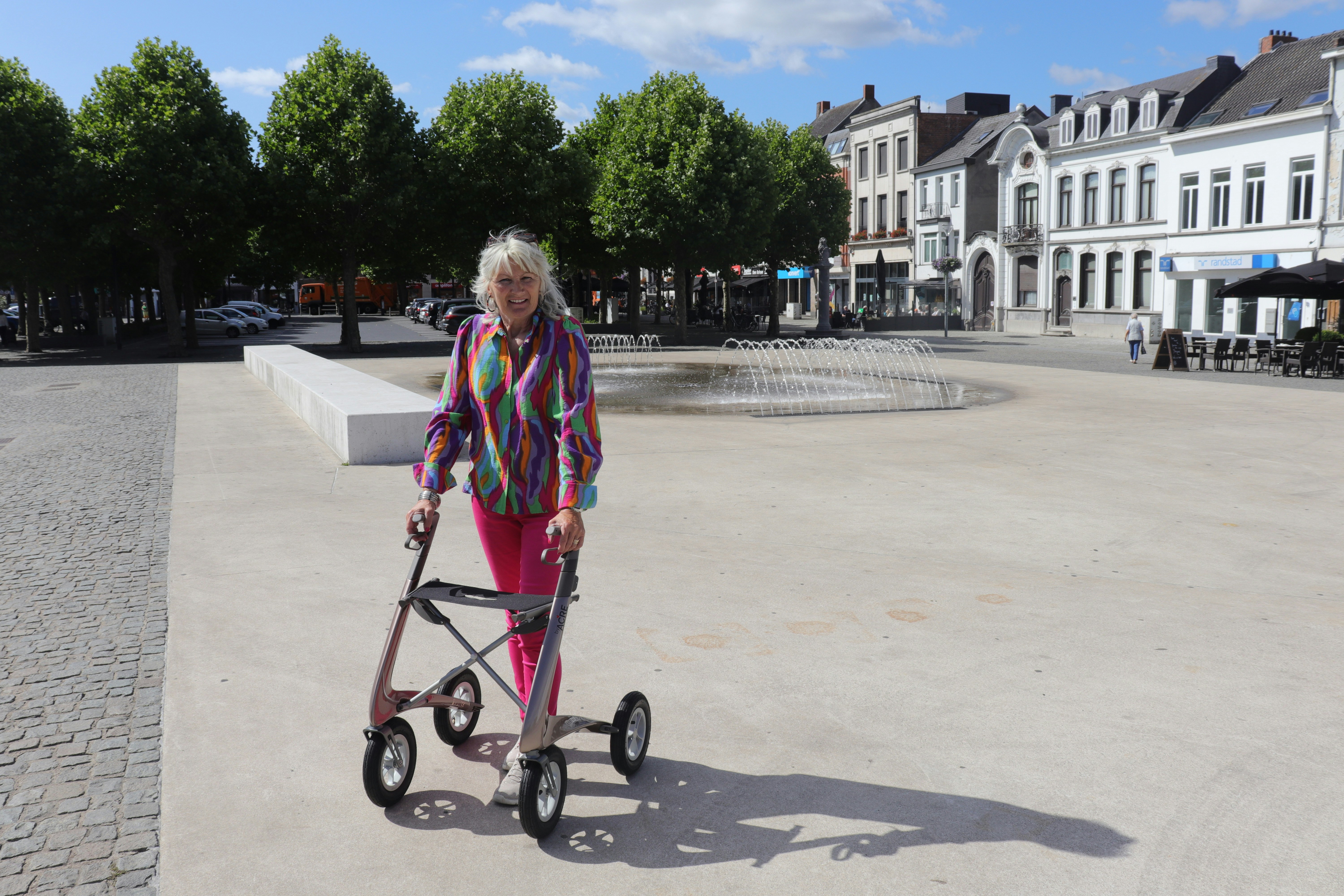 Elderly woman with walker in town square