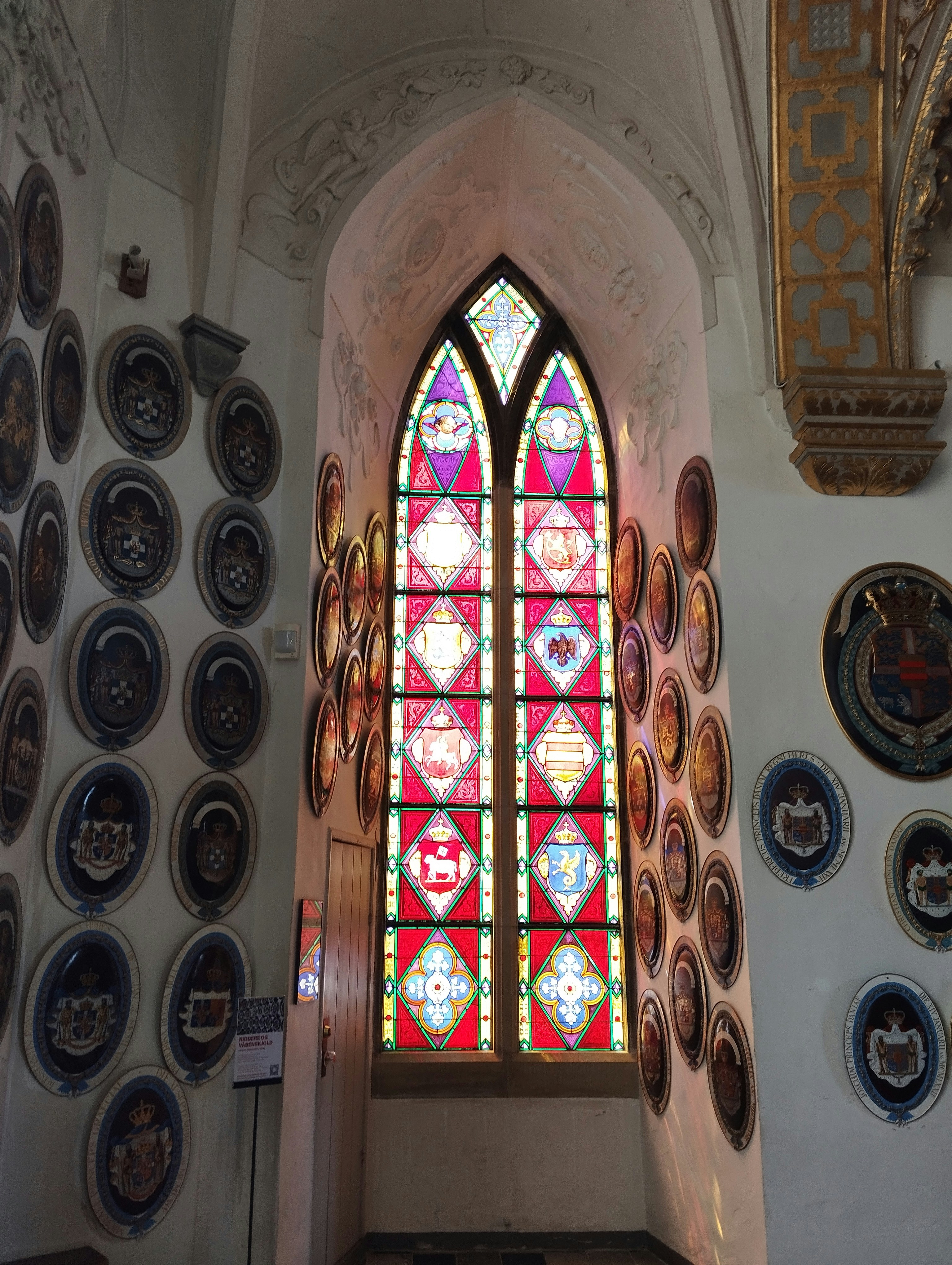 Gothic window with stained glass and wall decorations