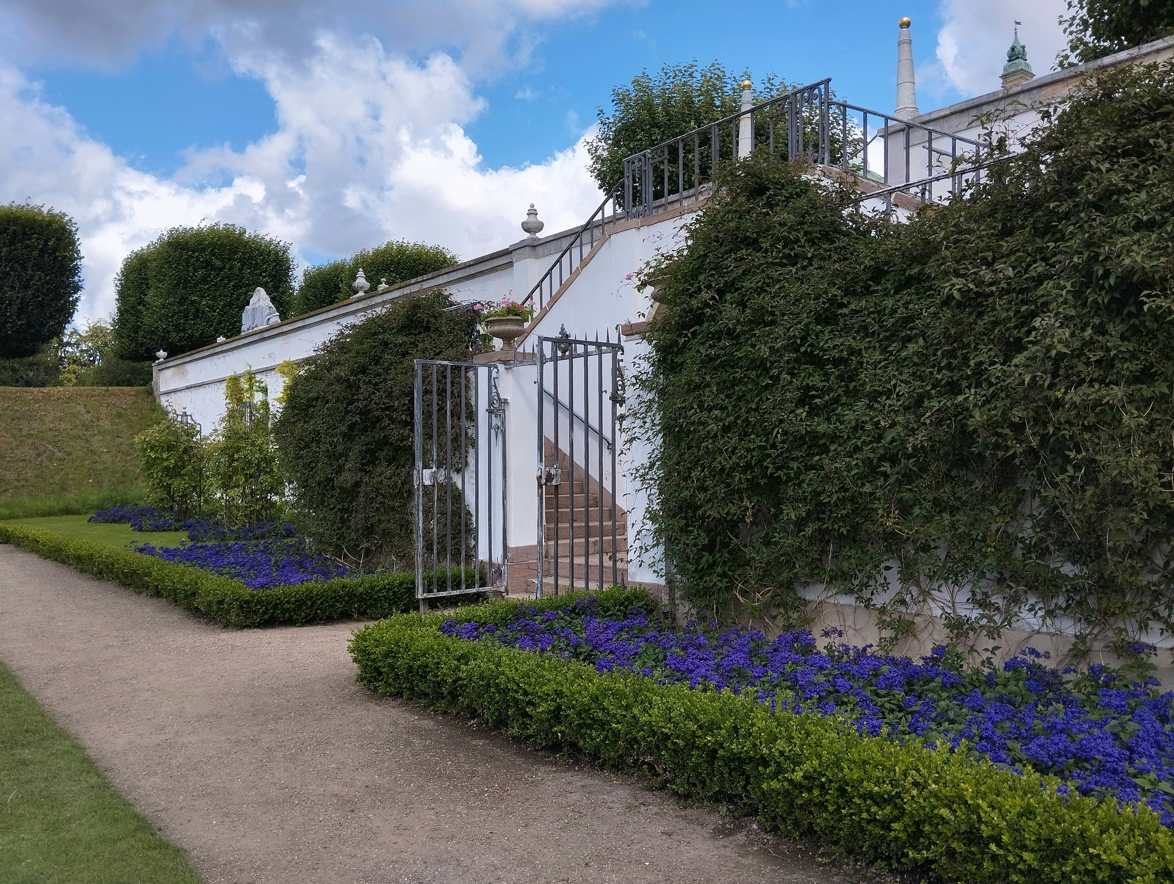 White building with stairs and purple flowers