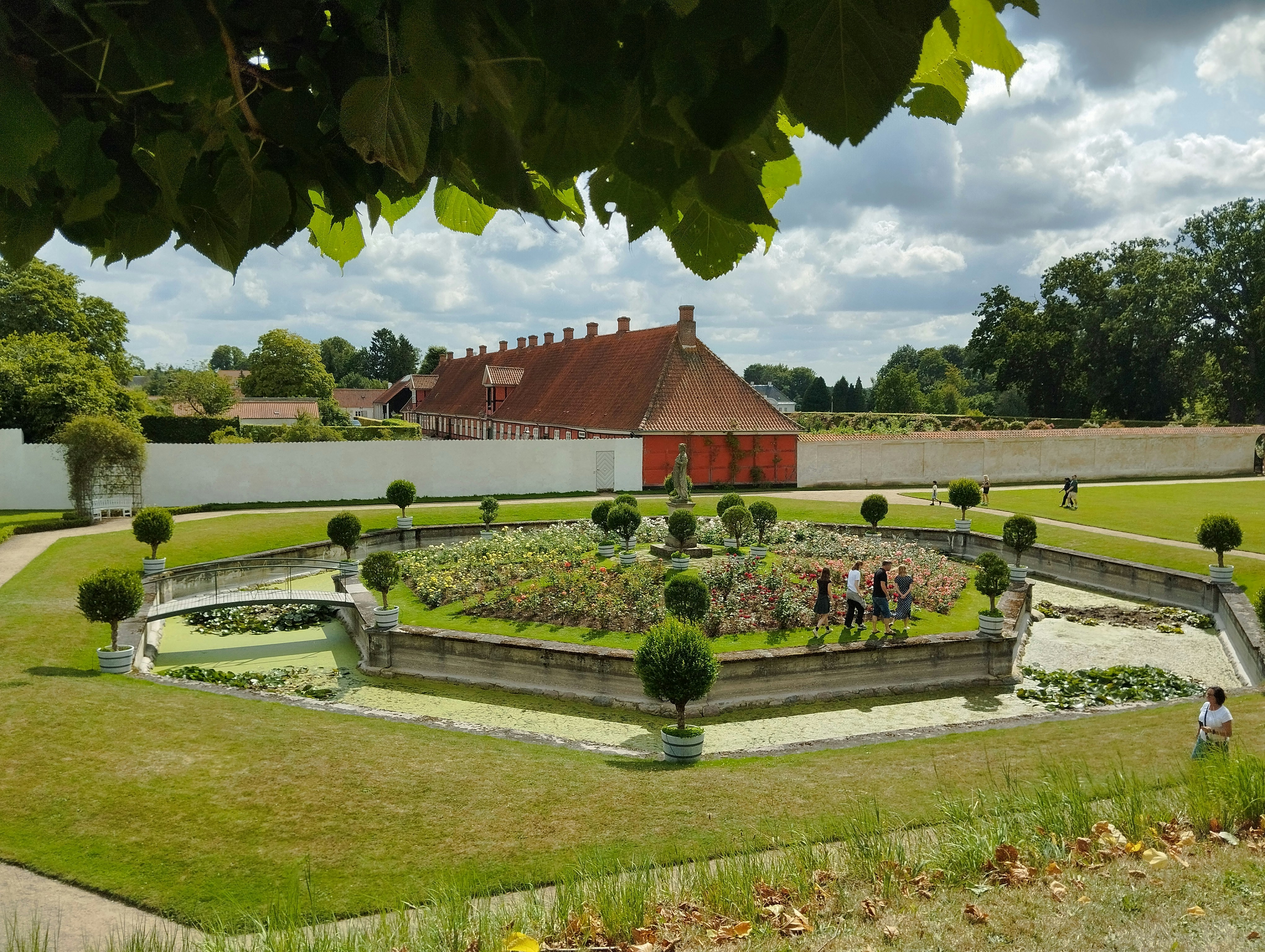 Formal garden with pond and red building