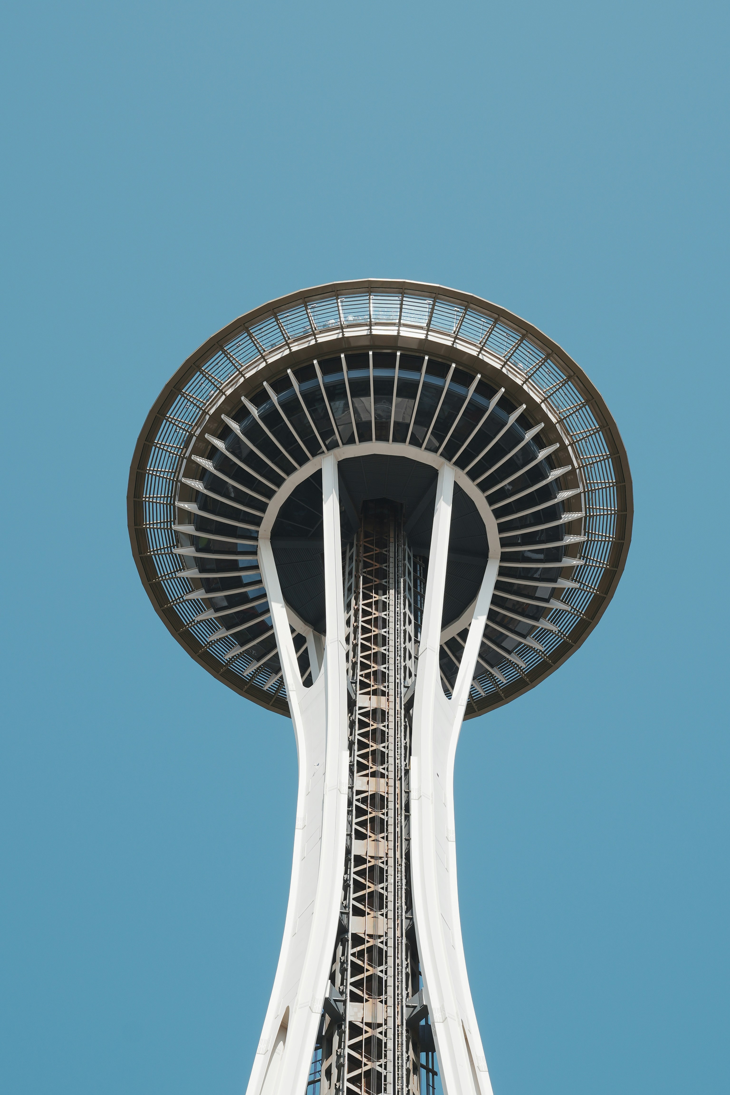 The Space Needle's unique structure rises against a clear blue sky, showcasing its architectural beauty and modern design.