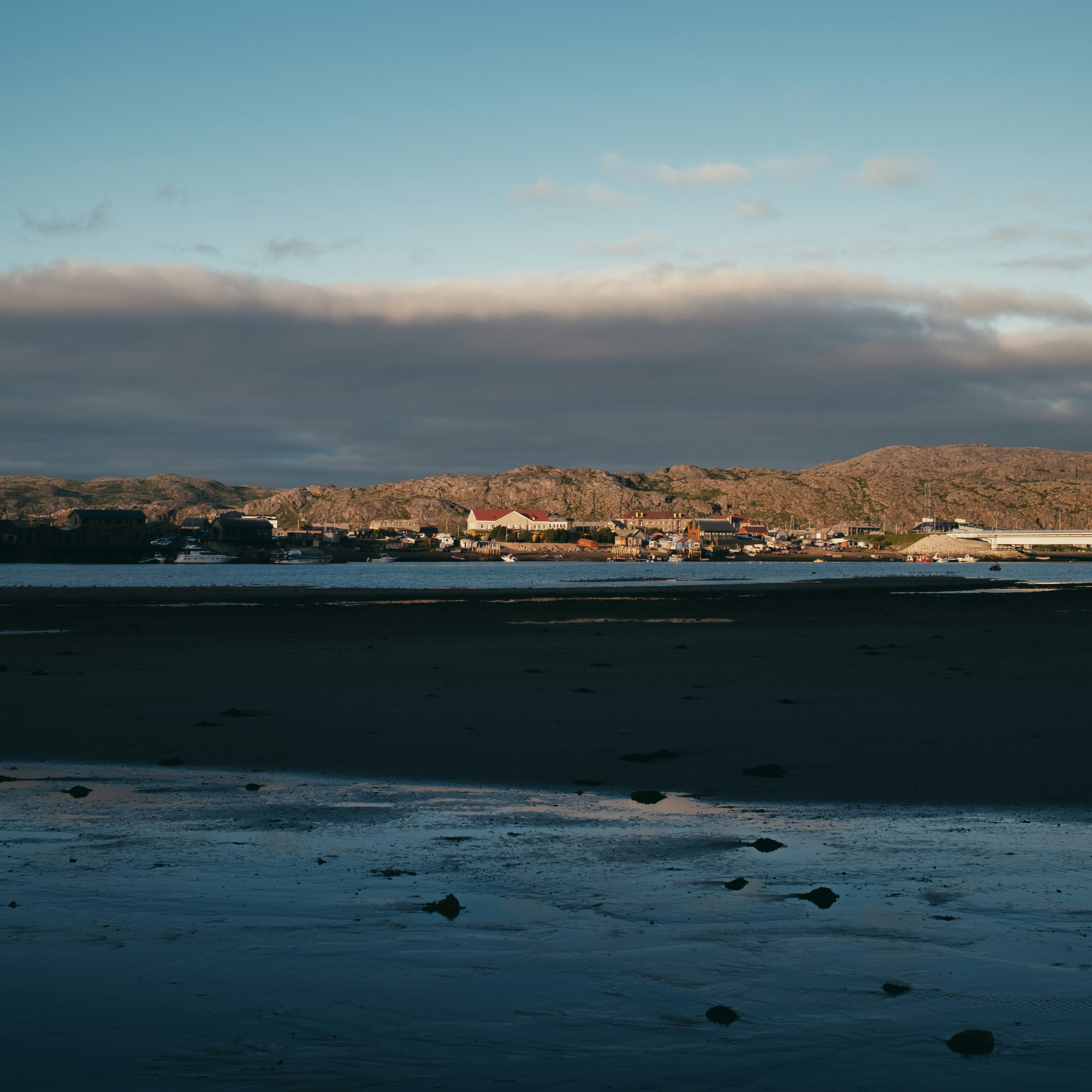 Coastal town with buildings on a hill near water