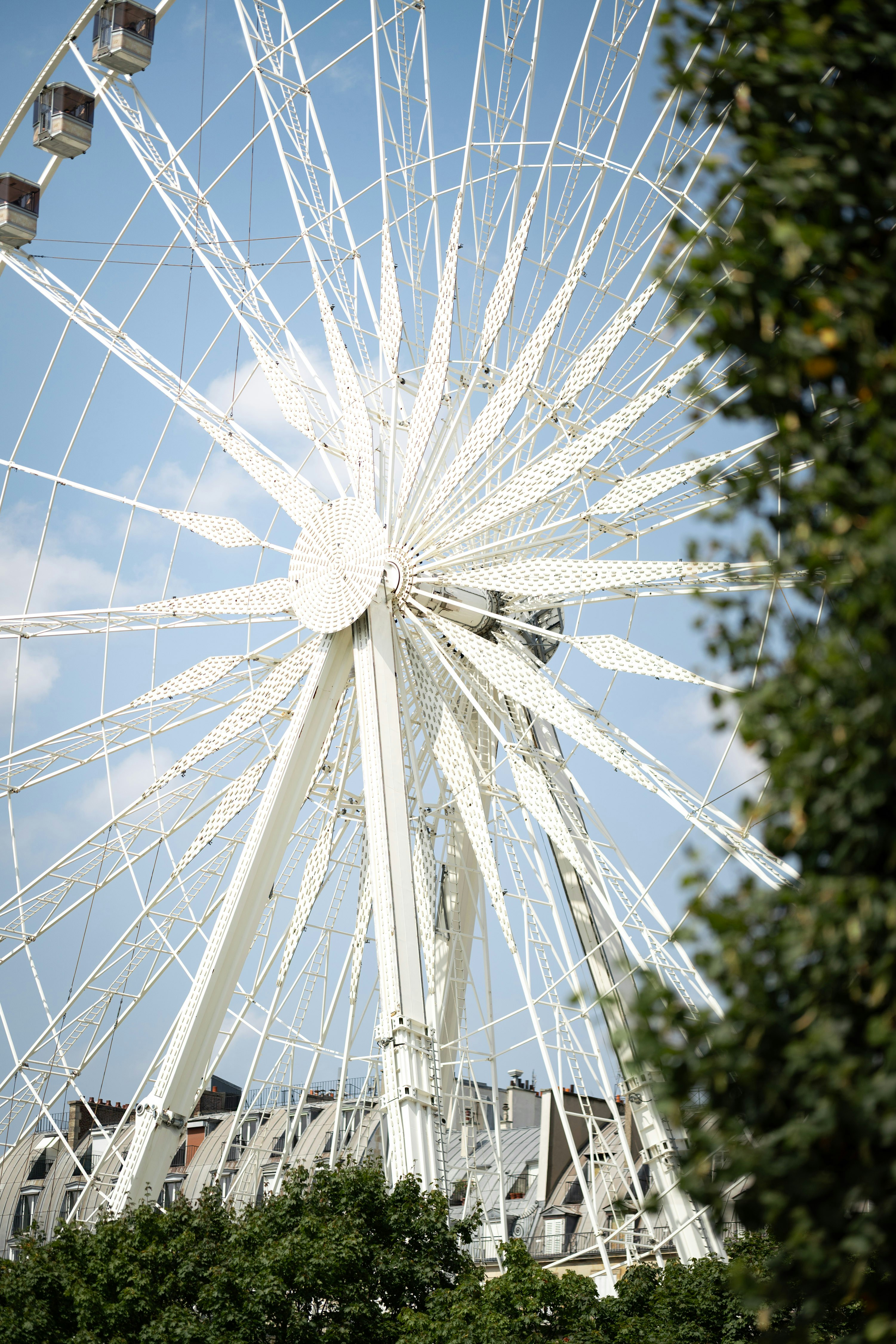 White ferris wheel against a blue sky