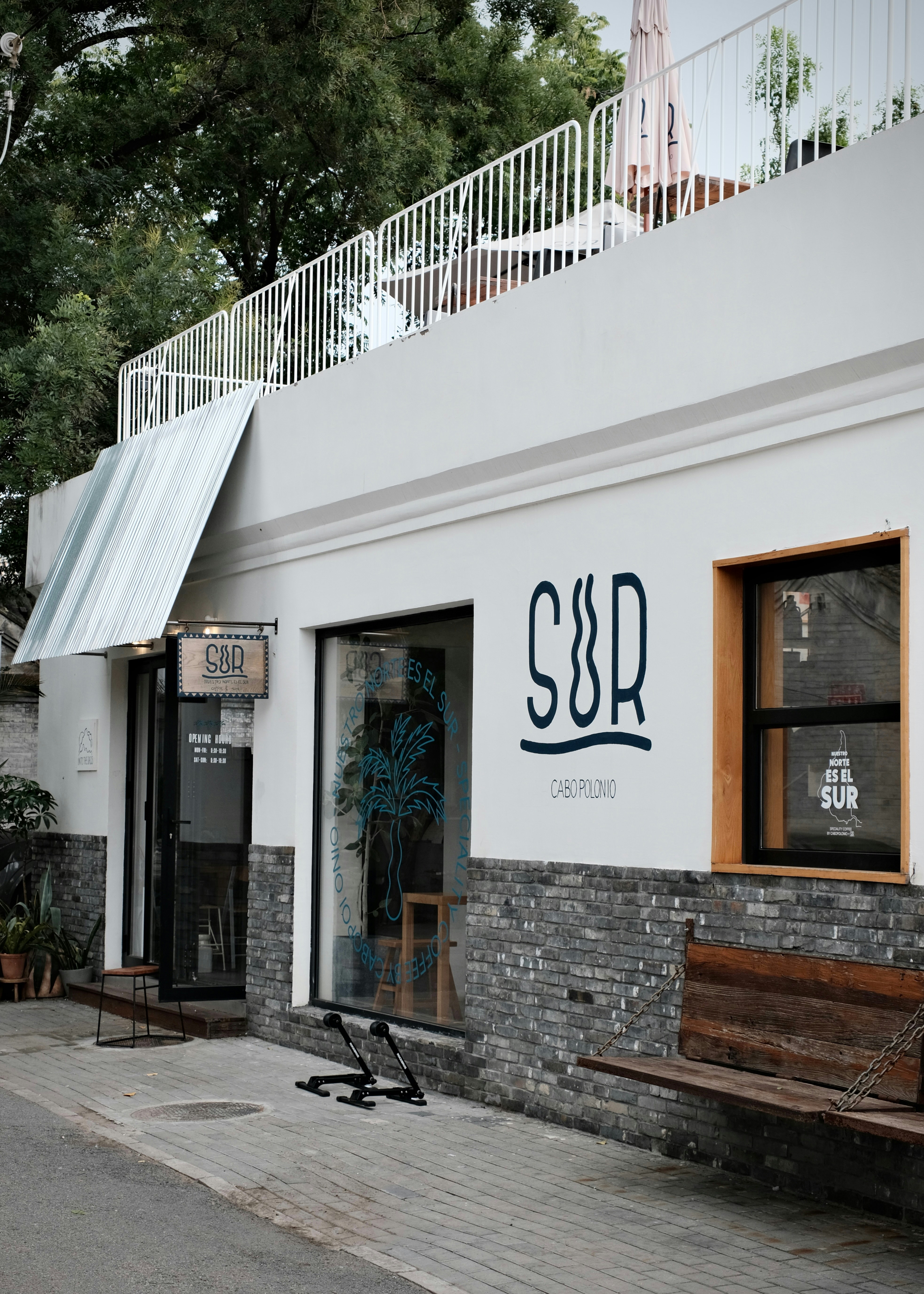Modern building exterior with outdoor seating and signage