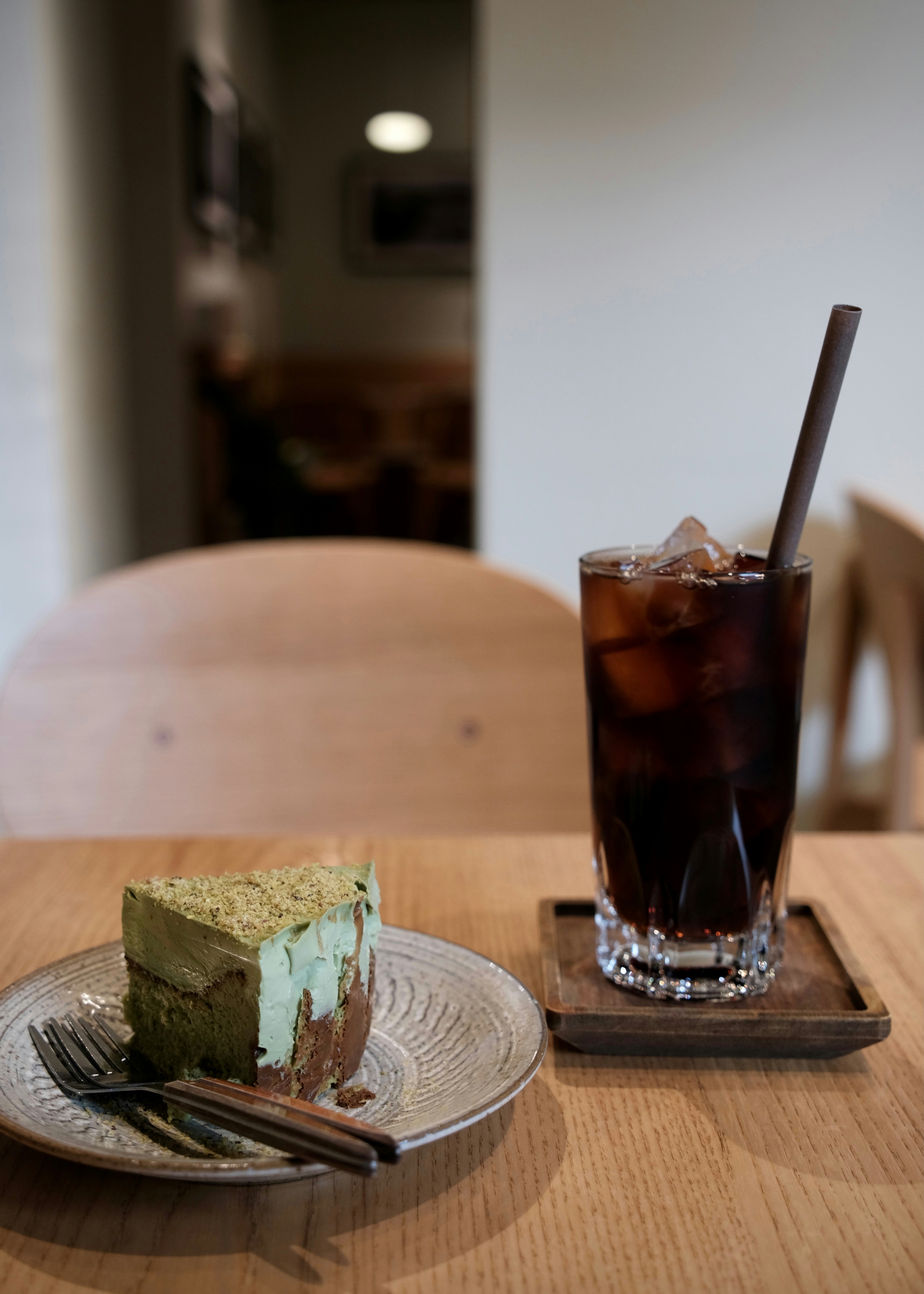 Slice of green tea cake with iced coffee