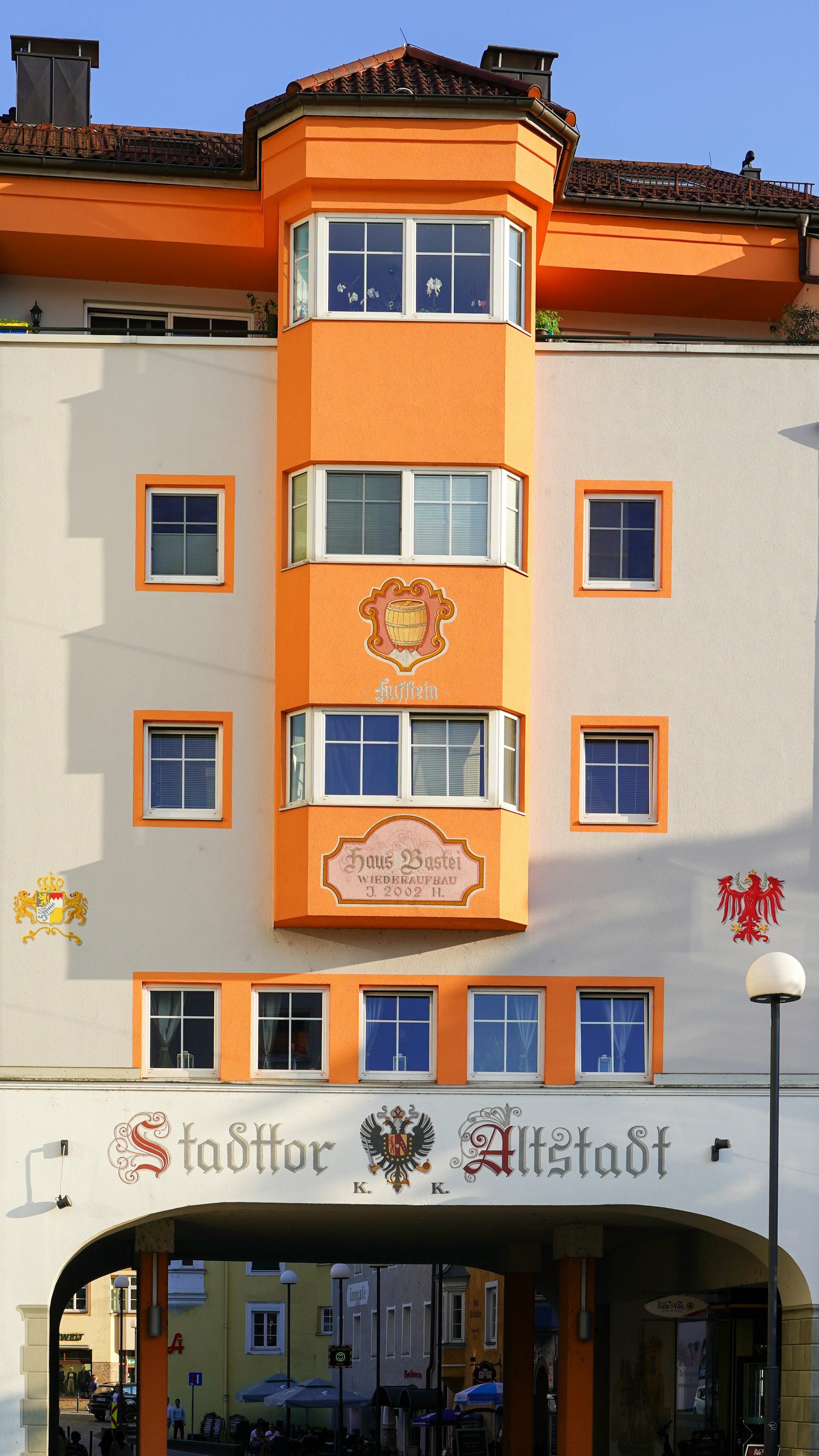 Colorful building facade featuring intricate details and a welcoming archway, showcasing the charm of urban architecture.