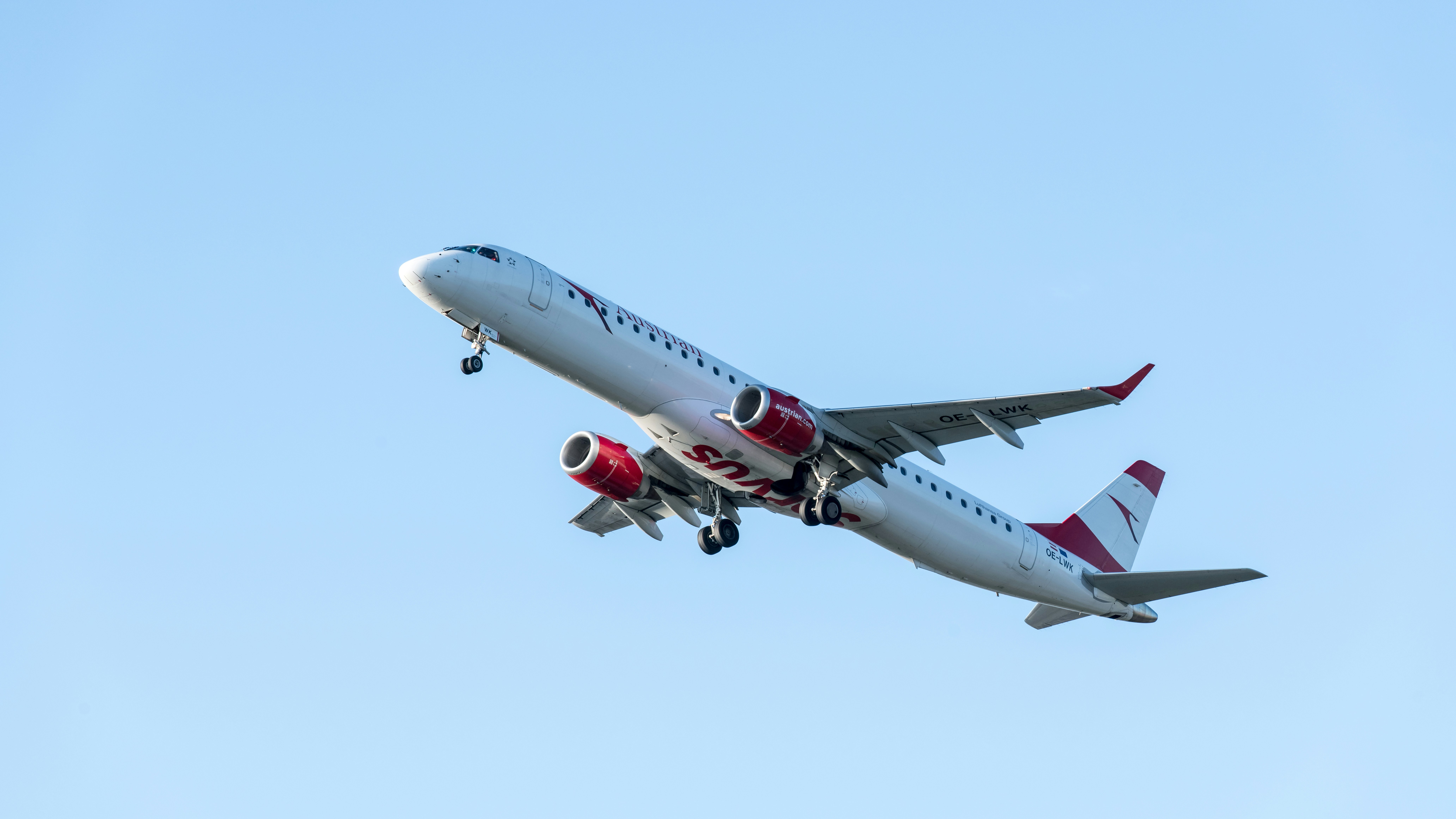 Commercial airplane ascending against a clear blue sky