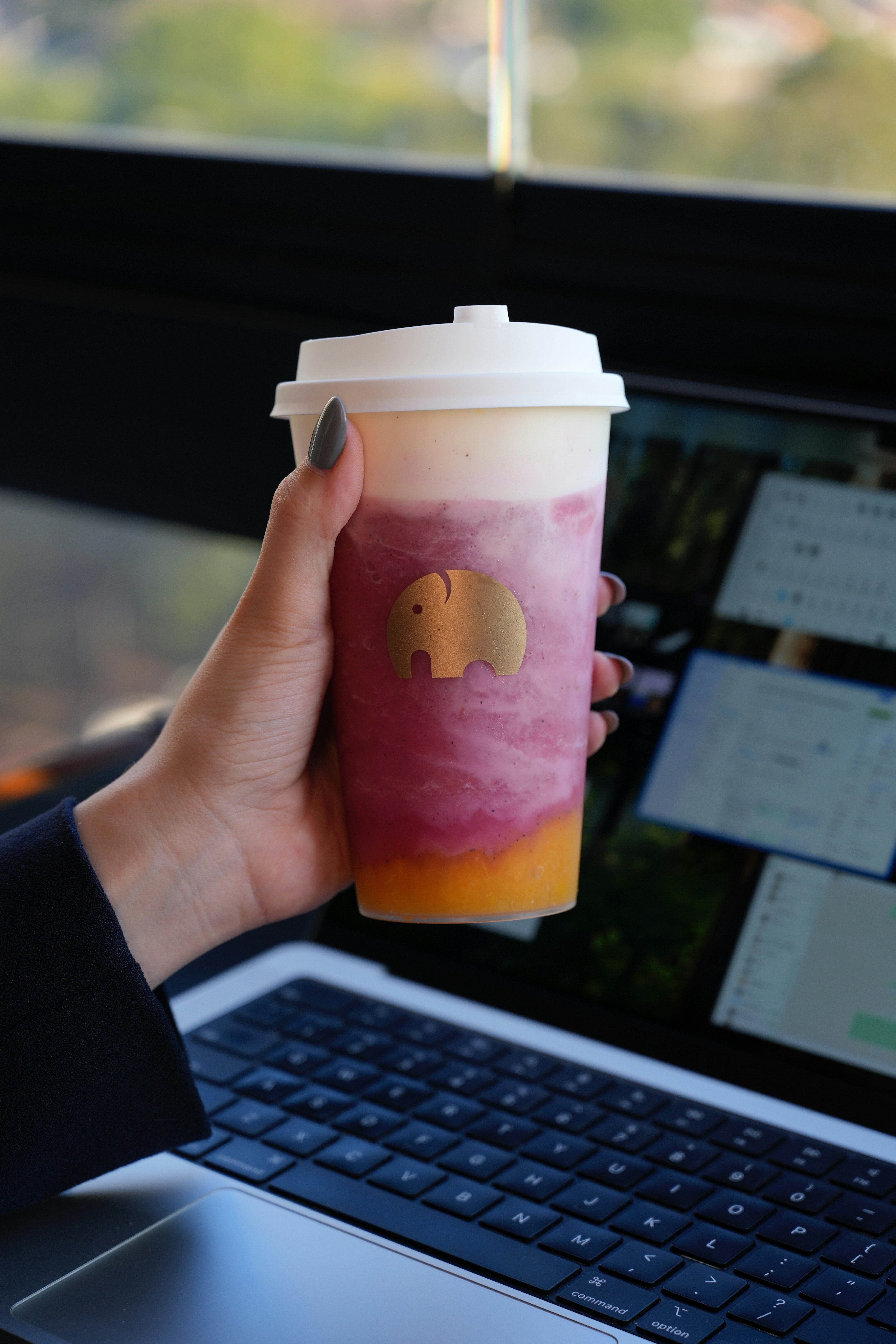 Purple Cloud Latte: A Hand-Held Sip in a Tech-Savvy Workspace