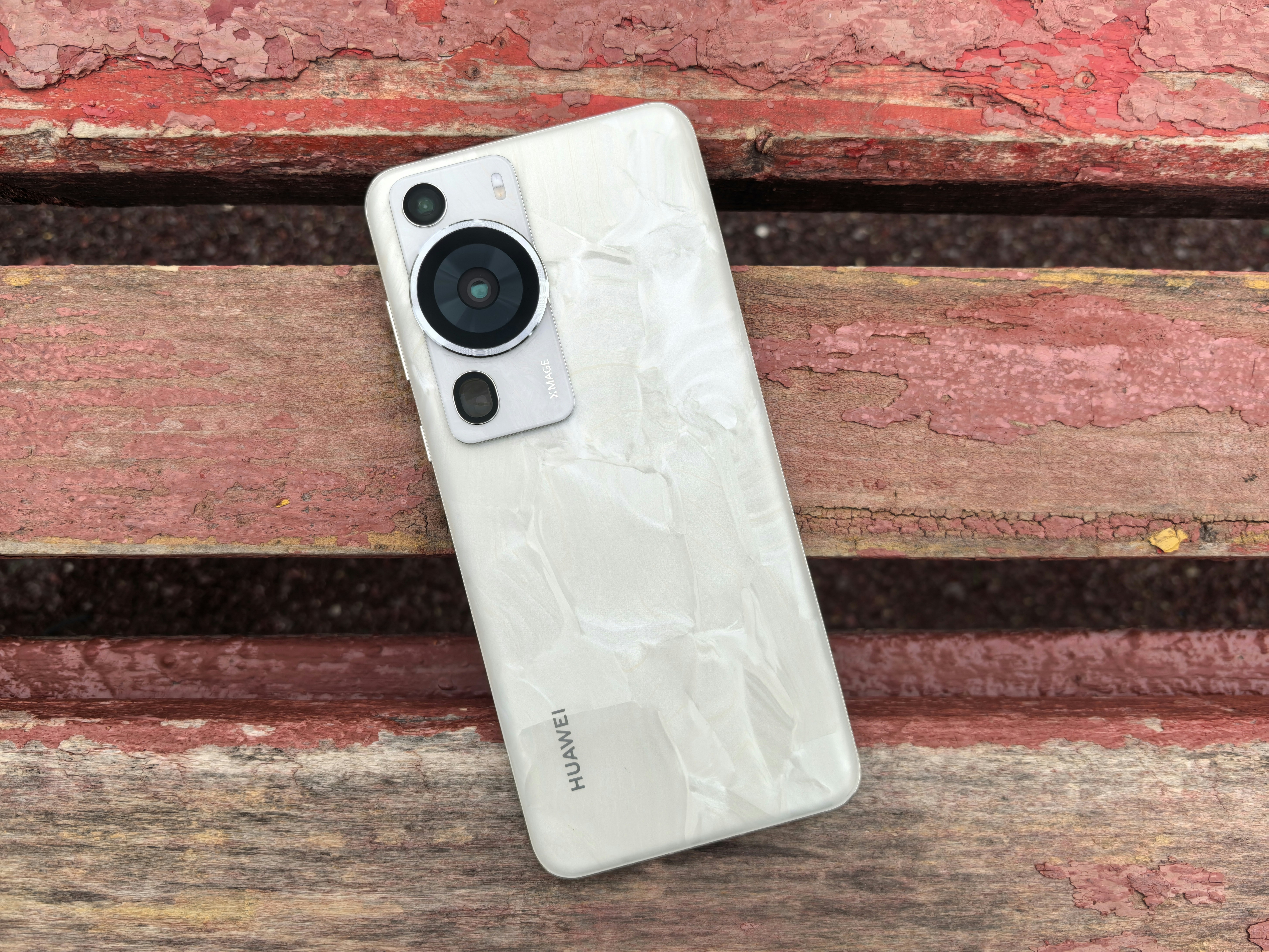 White smartphone with large camera on wooden surface