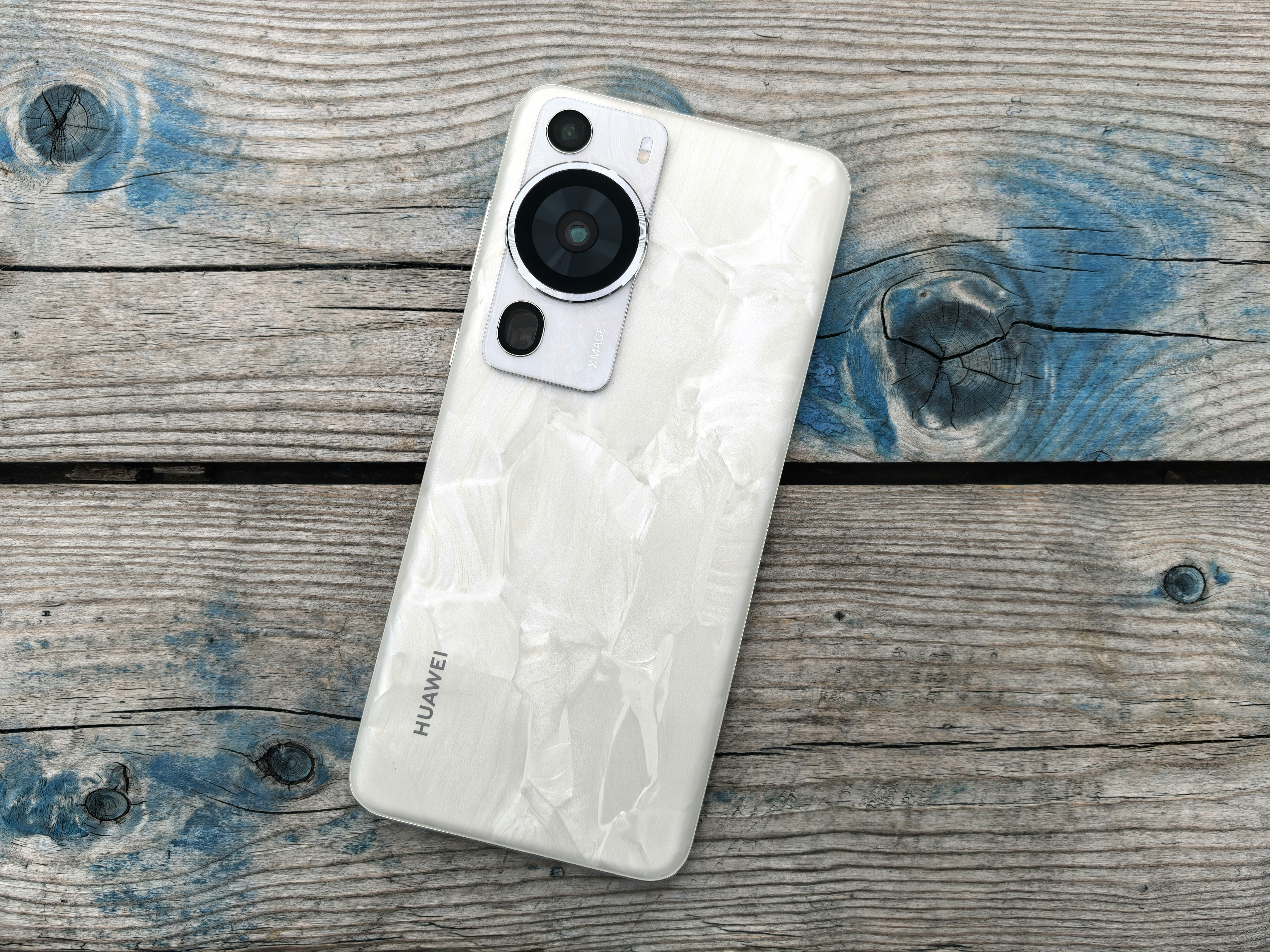 White smartphone with patterned back on wooden surface