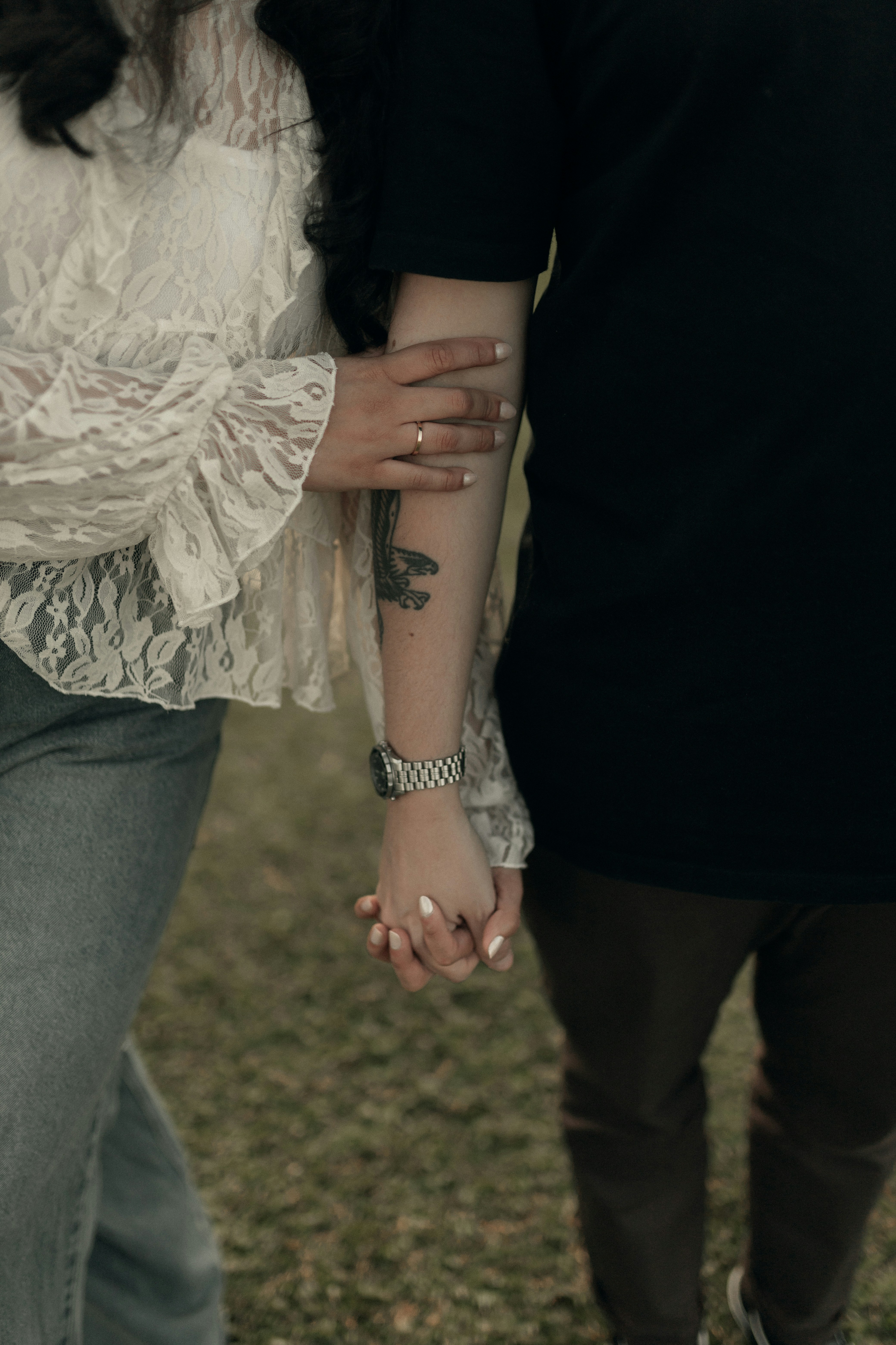 Couple holding hands while walking outdoors