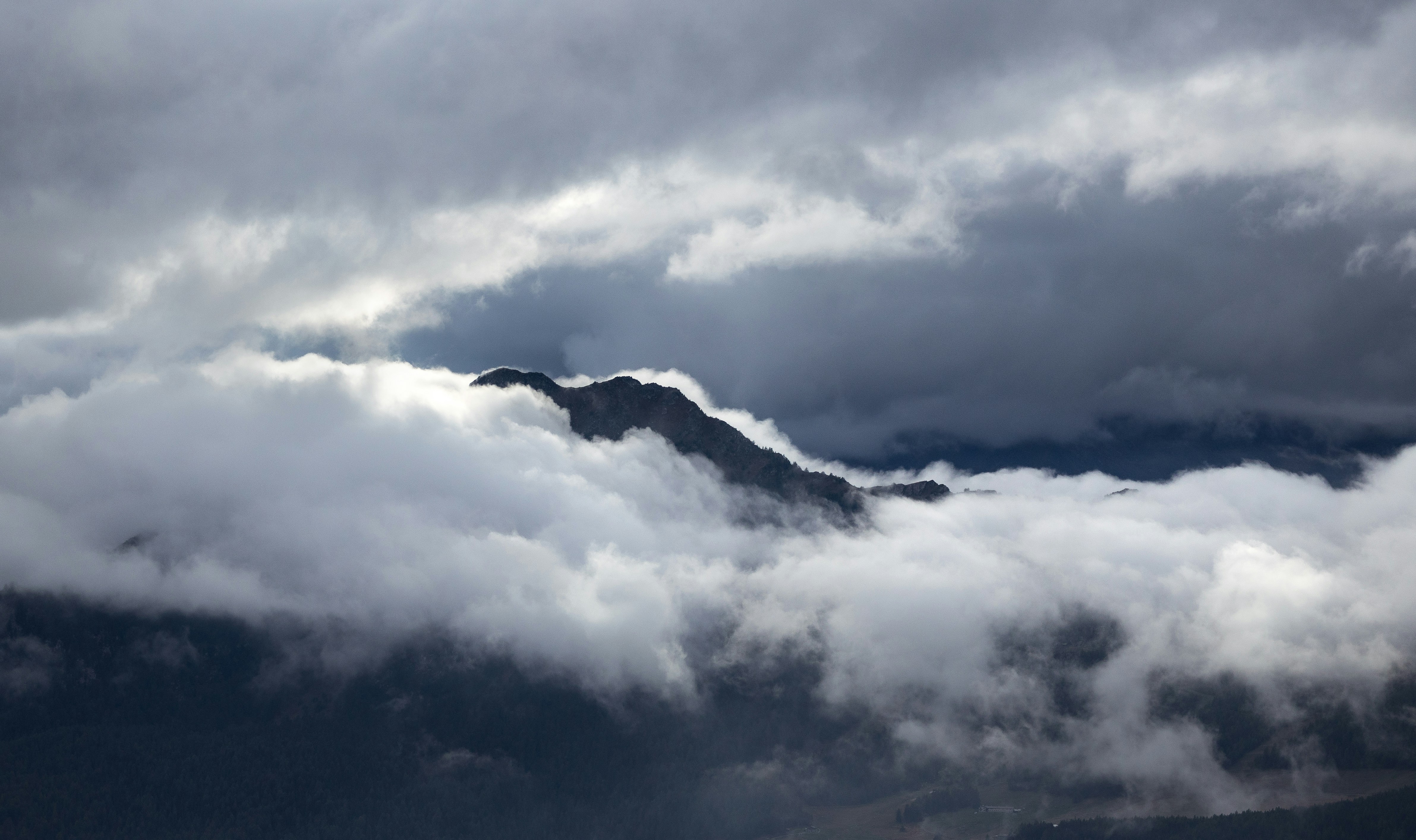 "In Clouds" | Mountain peak emerging from dramatic clouds