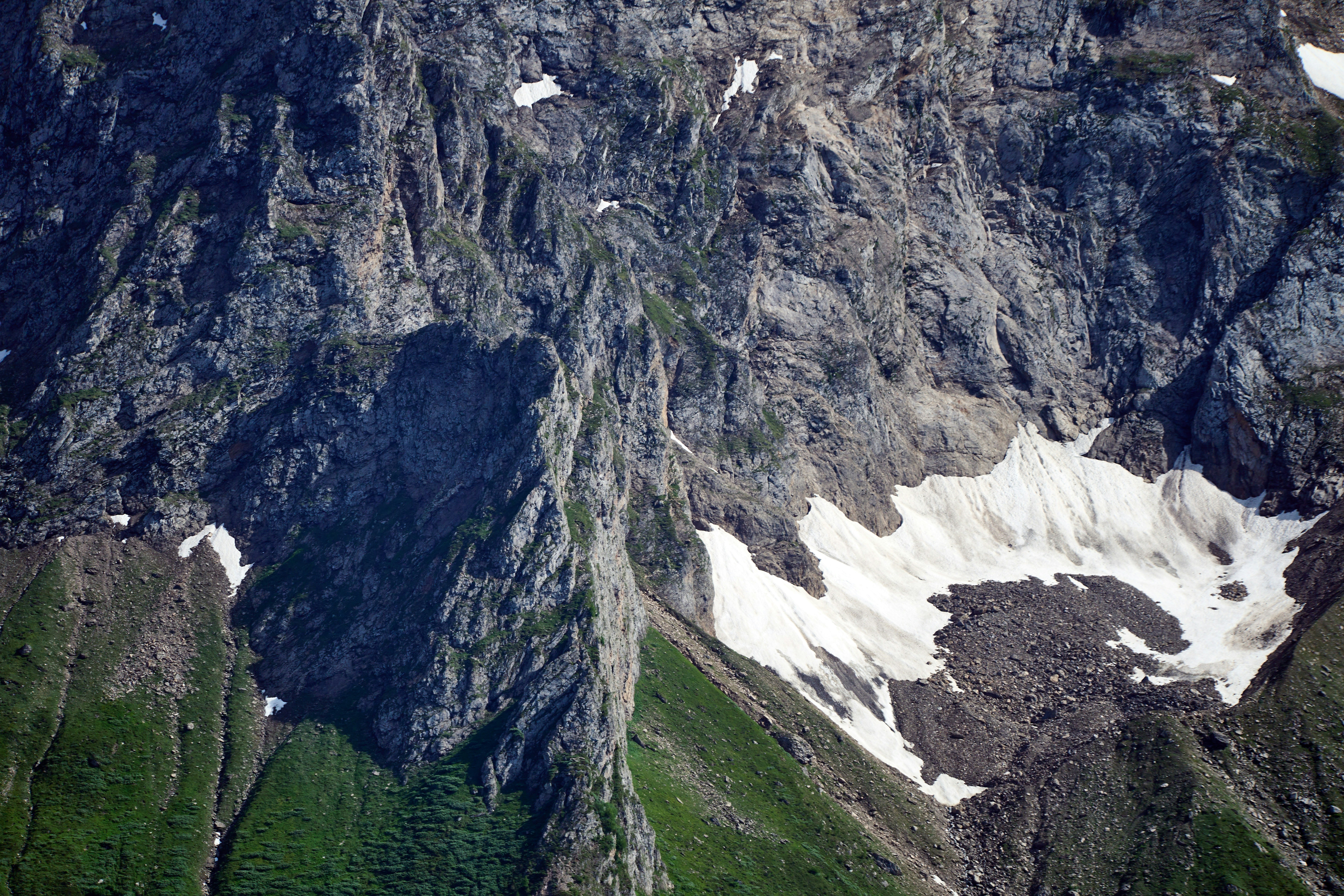 Jagged mountain peak rises dramatically above a glacier, showcasing the rugged beauty of nature's artistry.