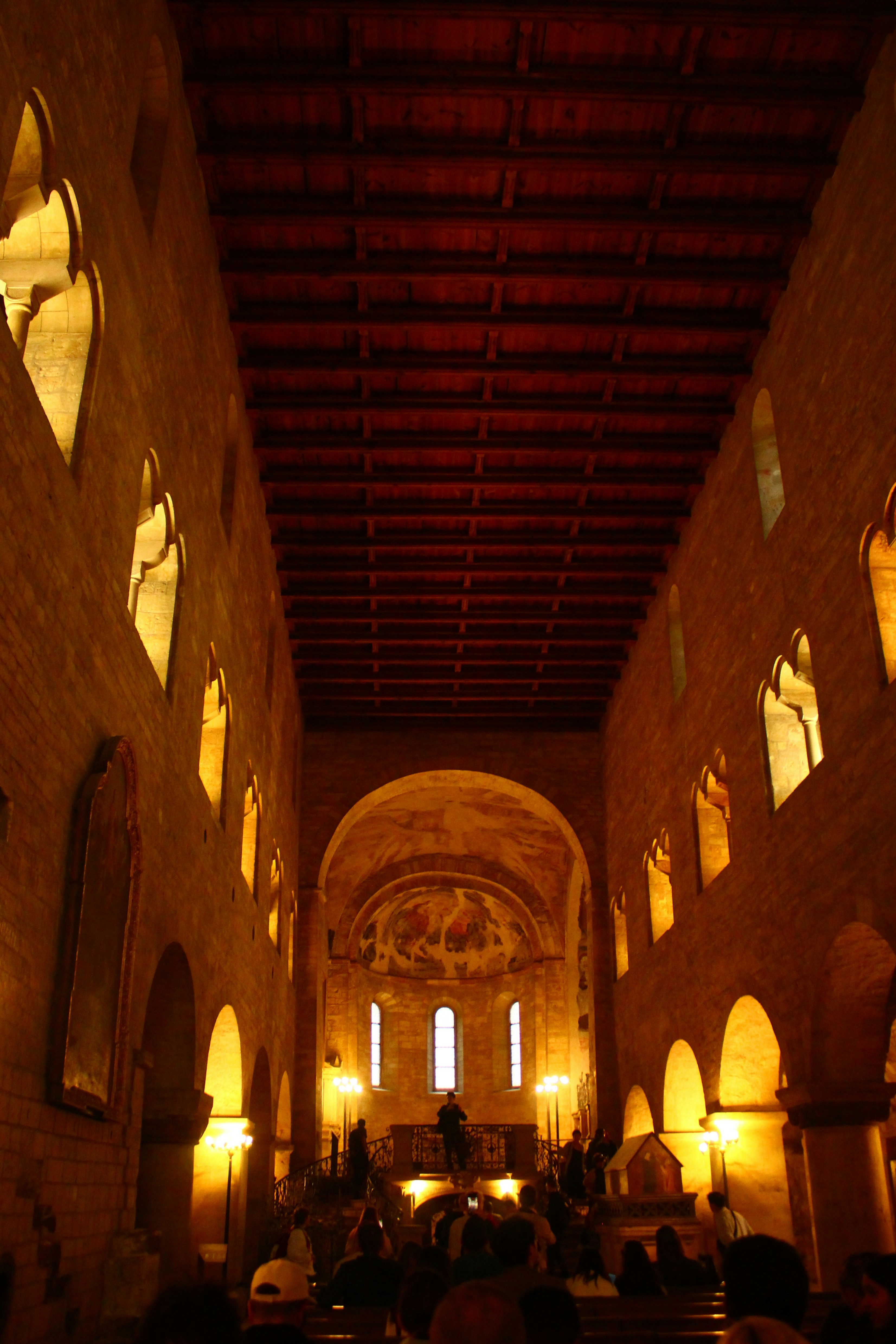 Interior of a grand cathedral with arched windows and wooden ceiling