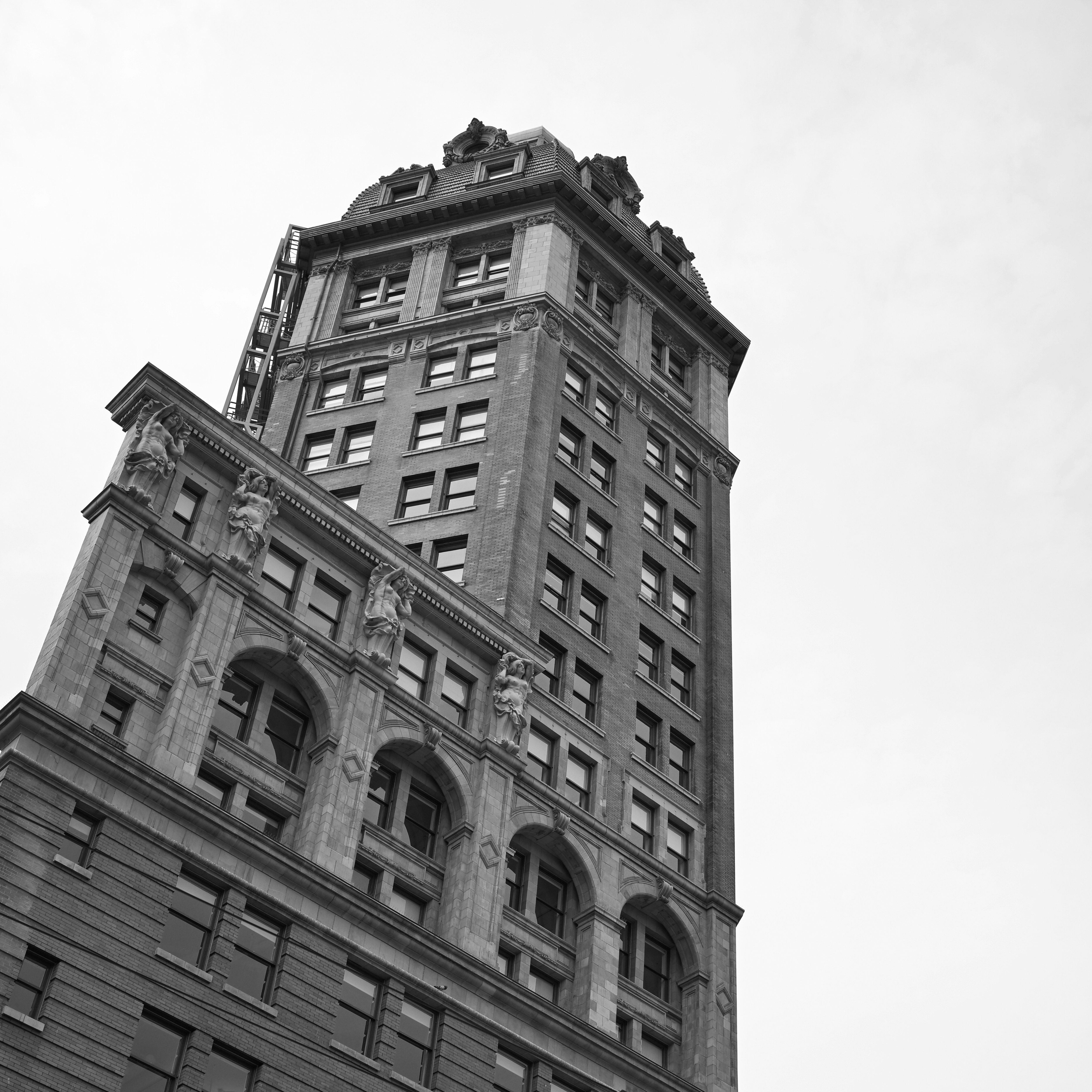 A tall, ornate building against a bright sky