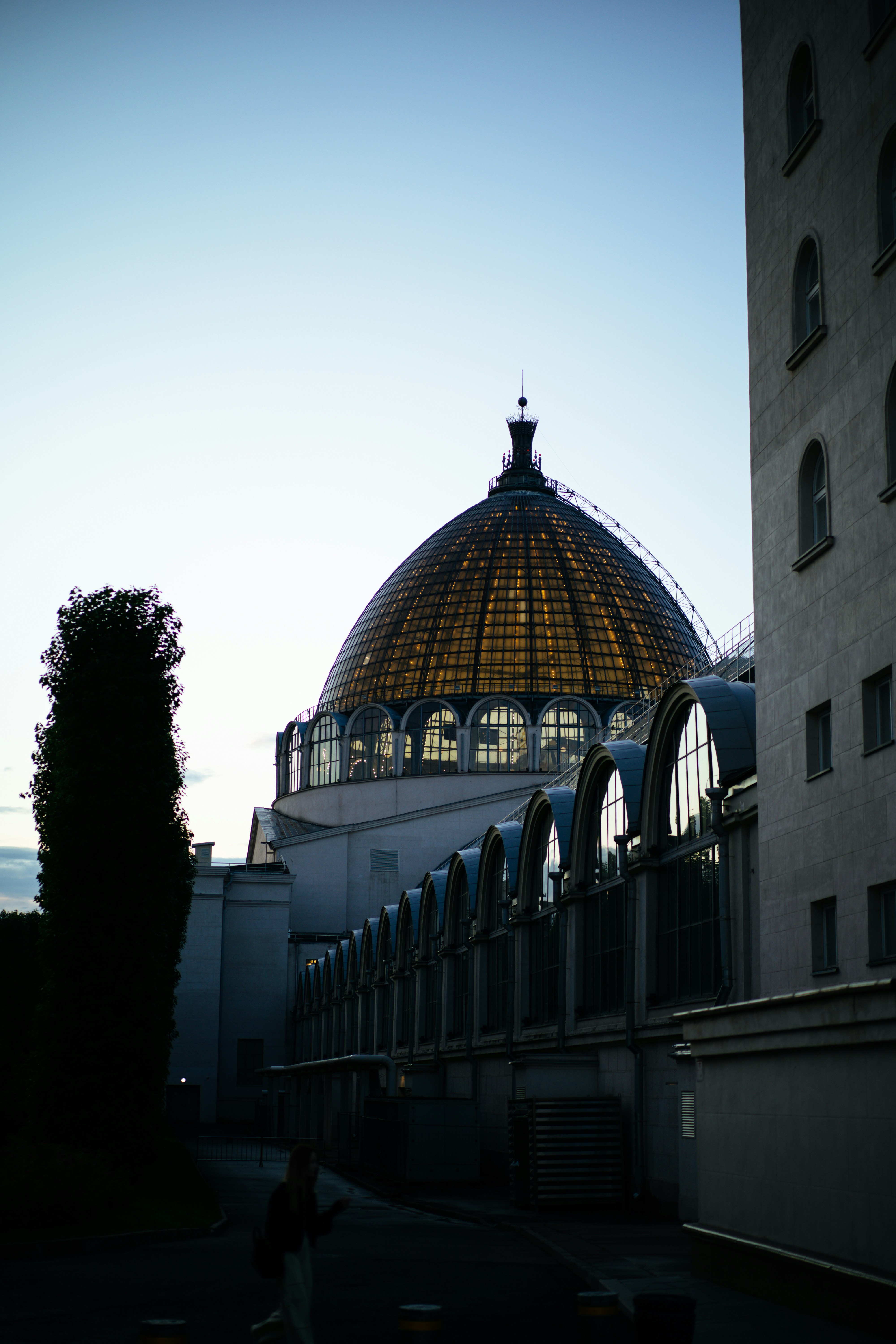 Golden dome building with arched windows at dusk