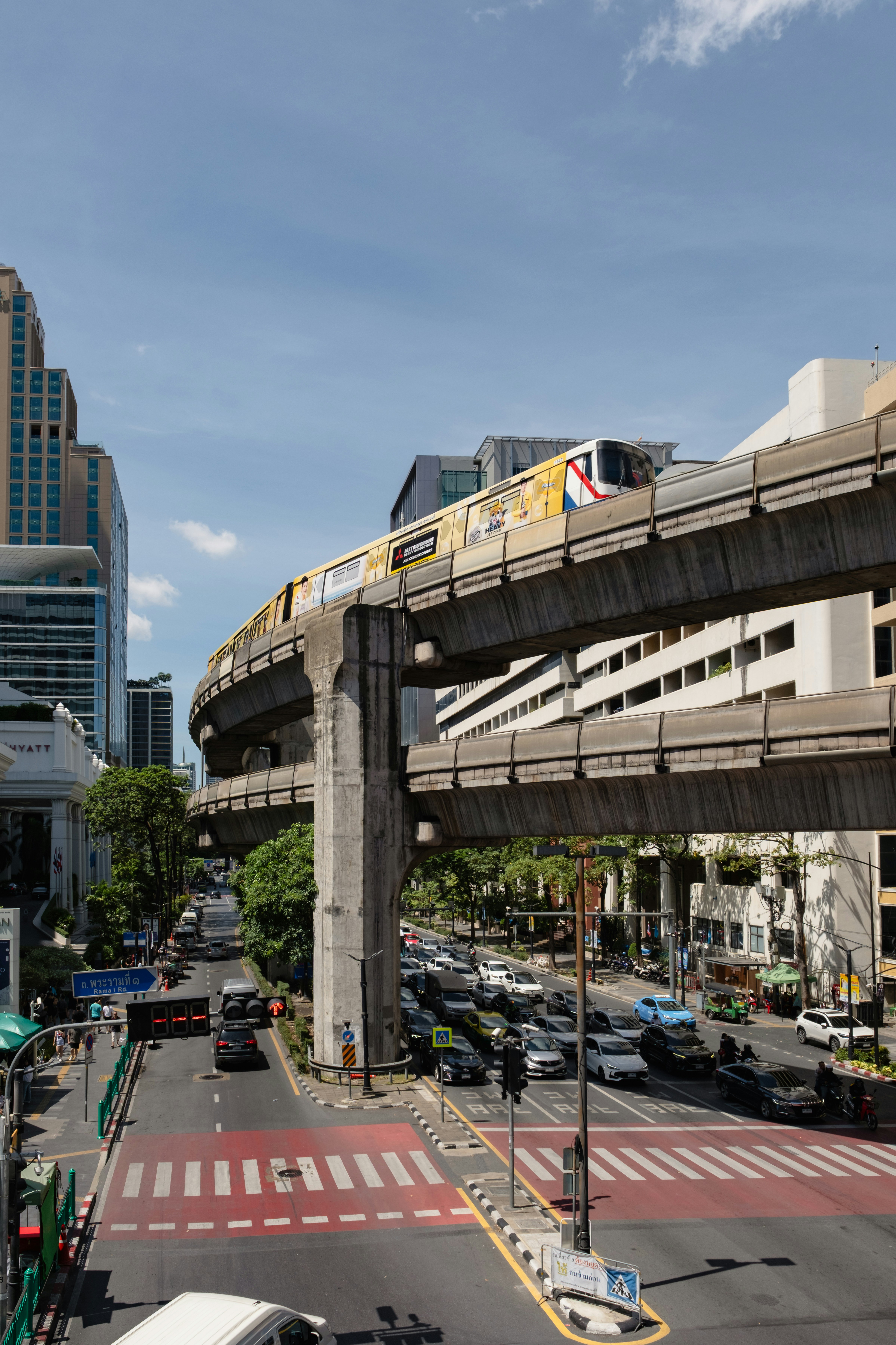 Elevated train tracks above a busy city street.