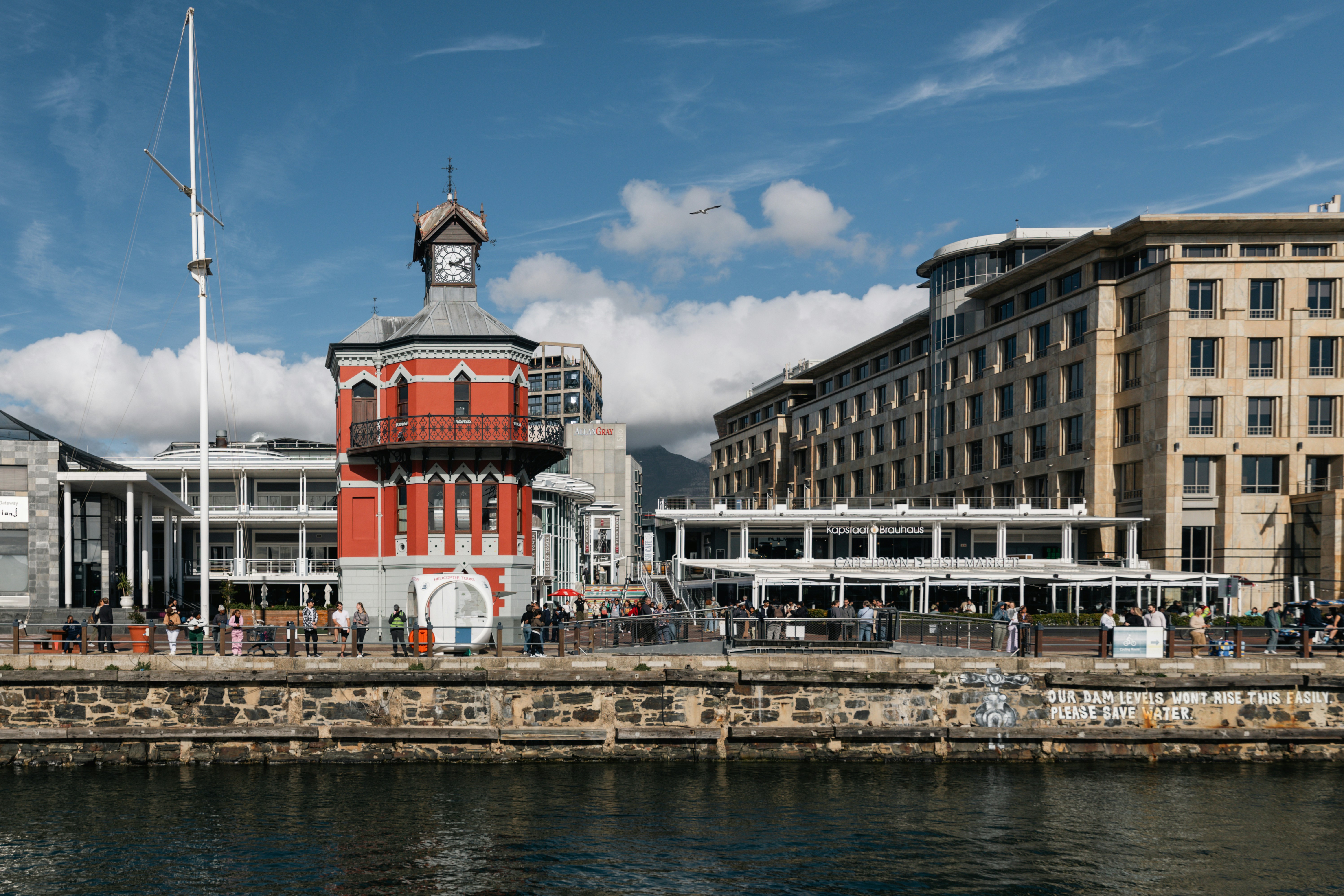 A waterfront view. | Historic red clock tower building by the water