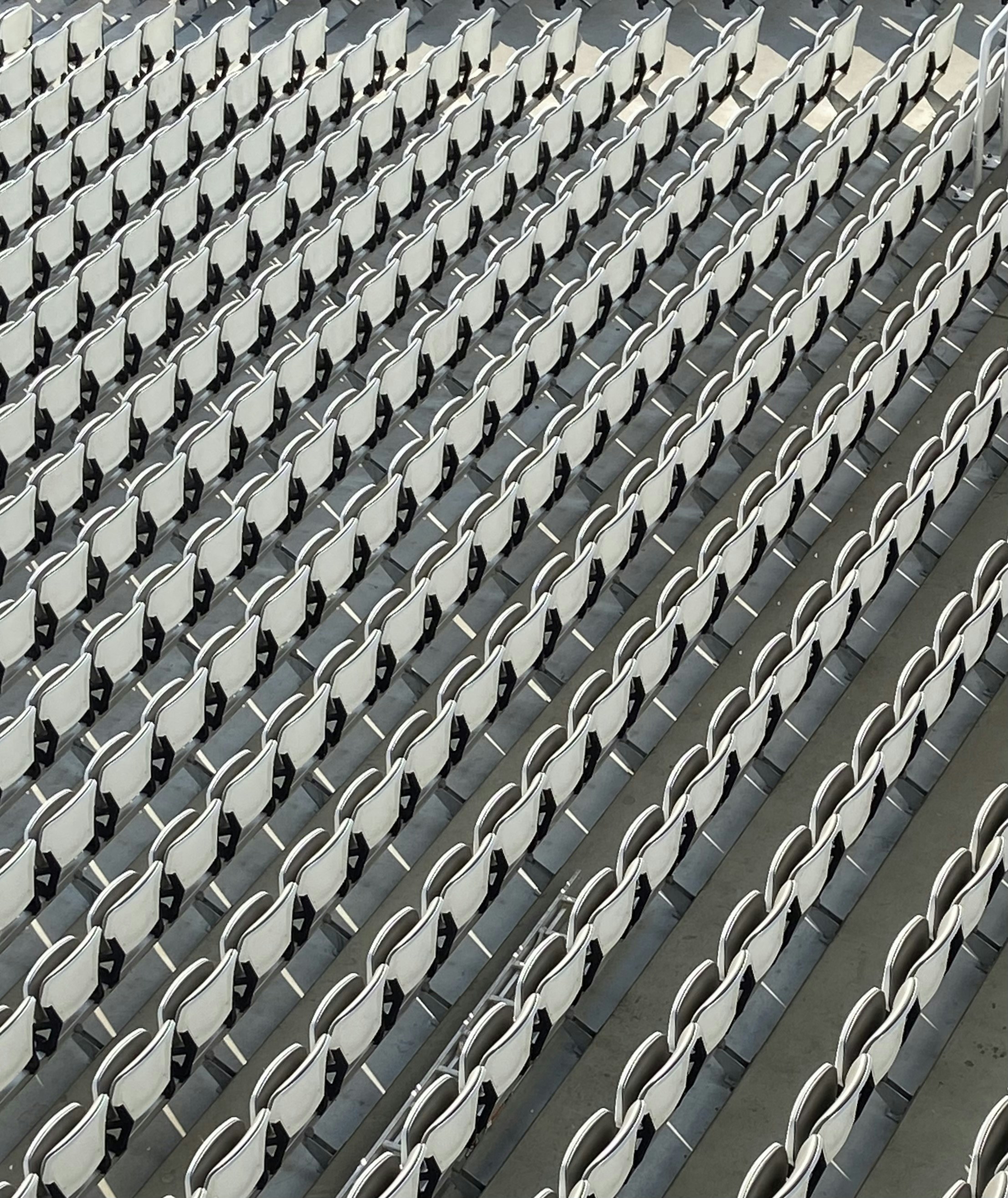 Rows of empty stadium seats viewed from above.