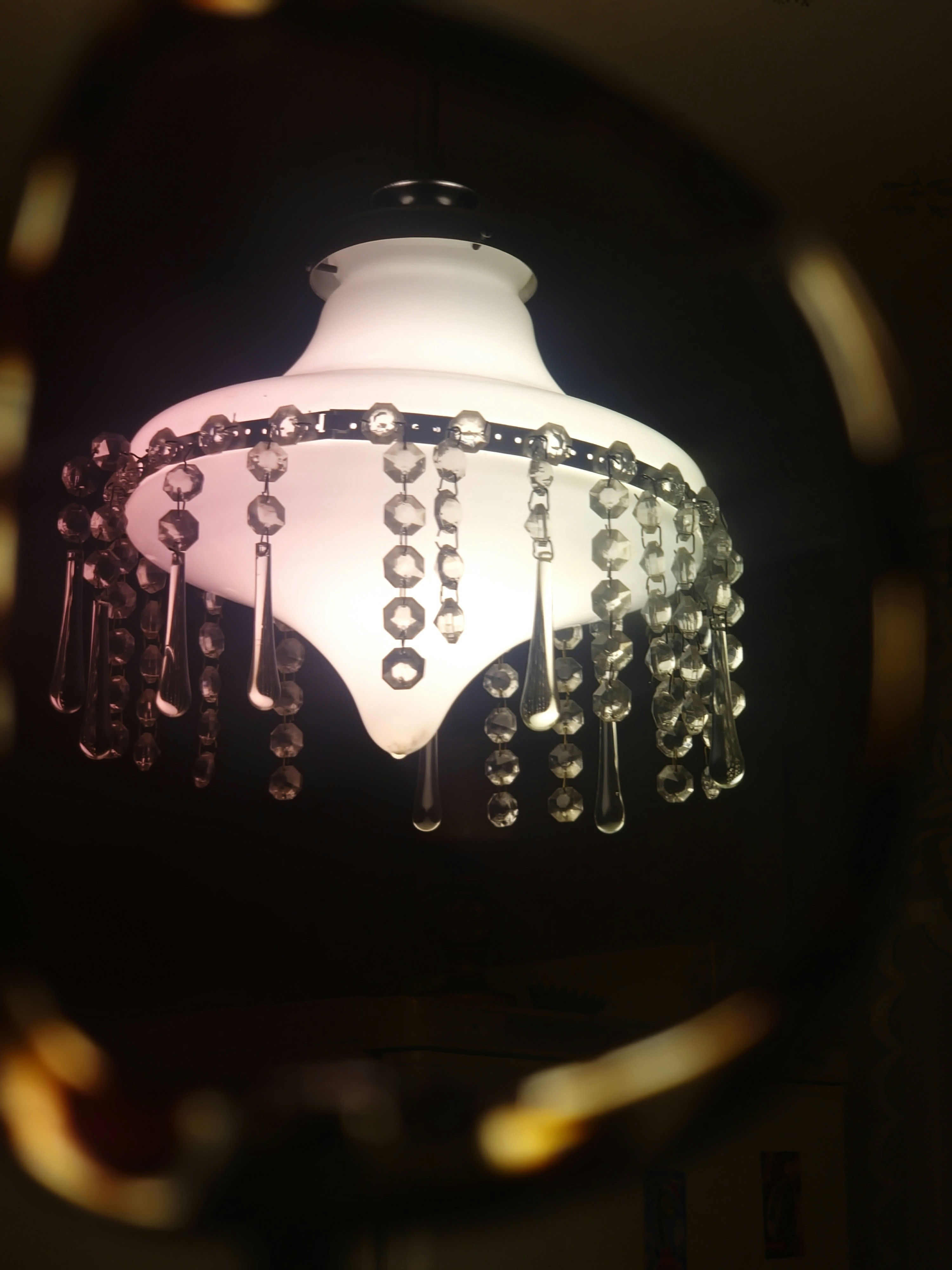 A vintage lamp with hanging crystal accents