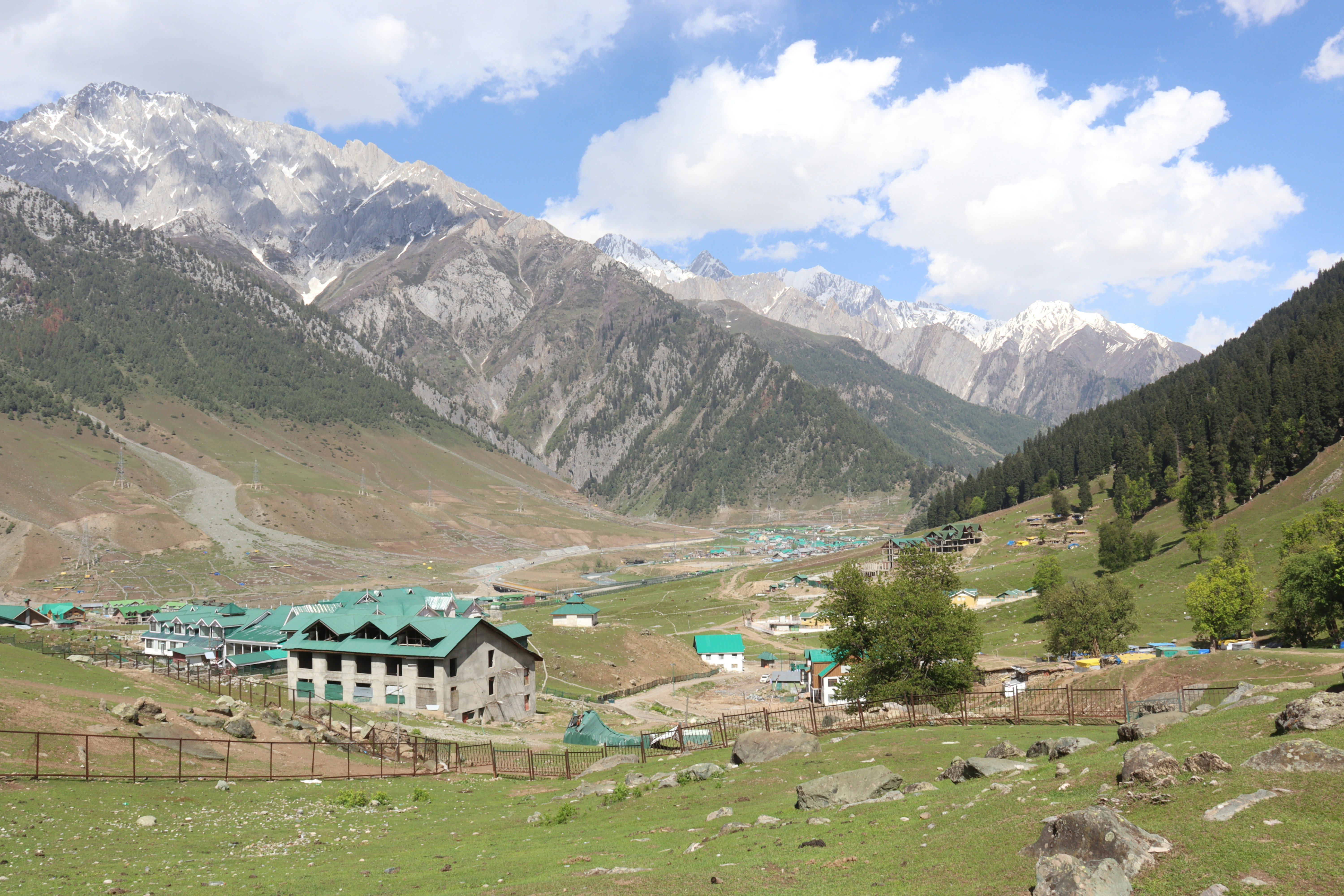 Green buildings nestled in a mountain valley