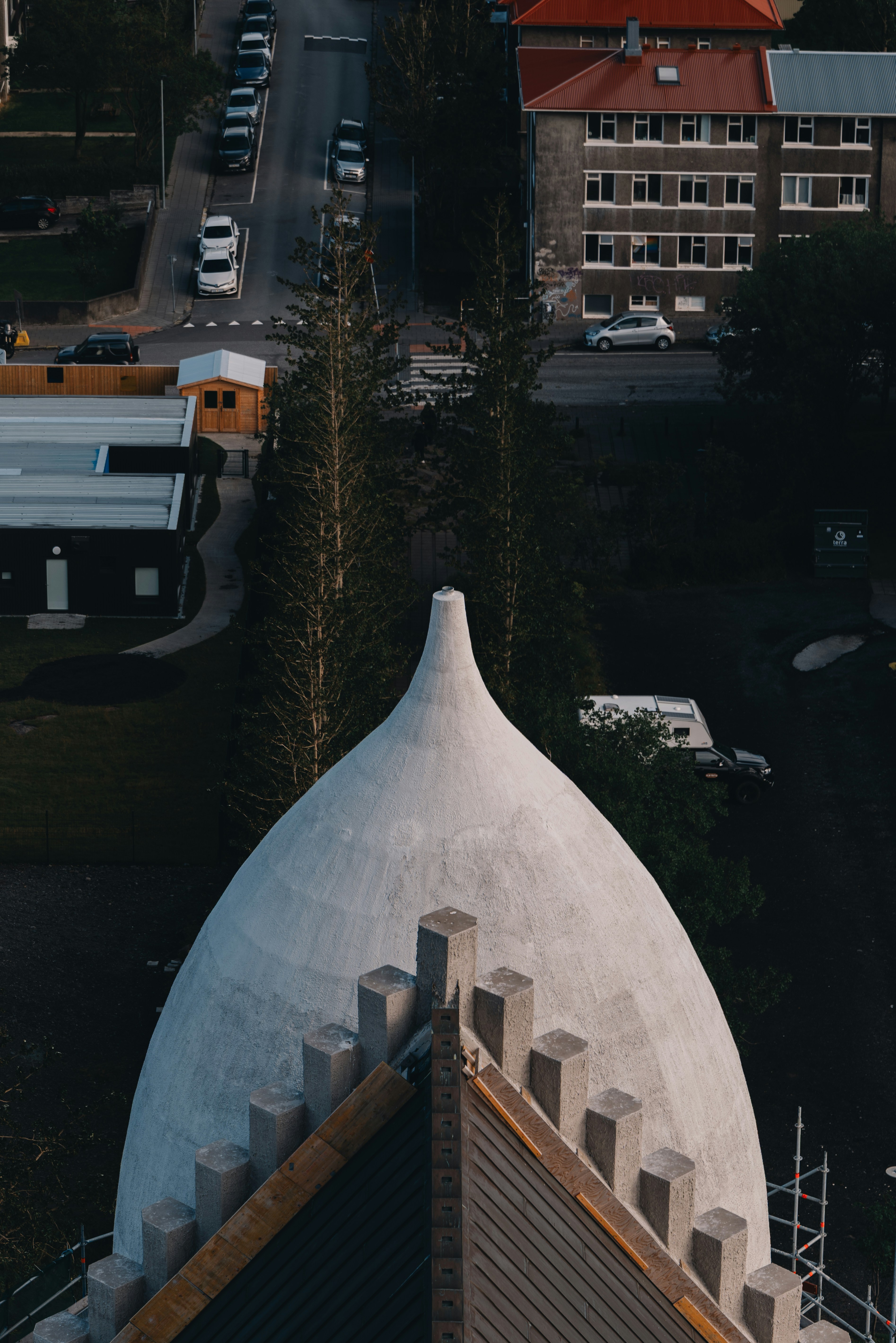 White dome structure with city street in background