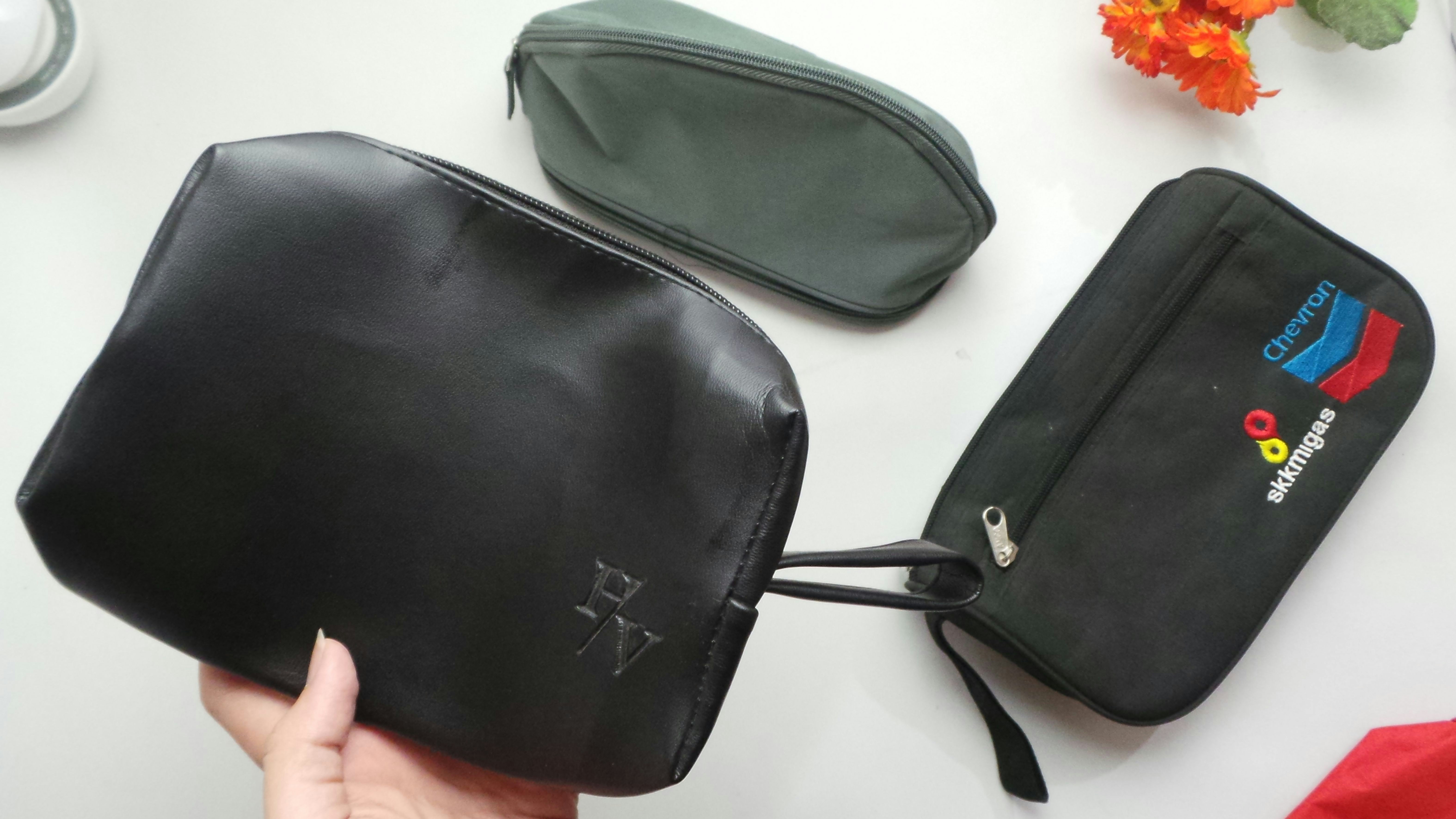 Produksi Aneka Pouch Custom Murah | Three cosmetic bags on a white surface.