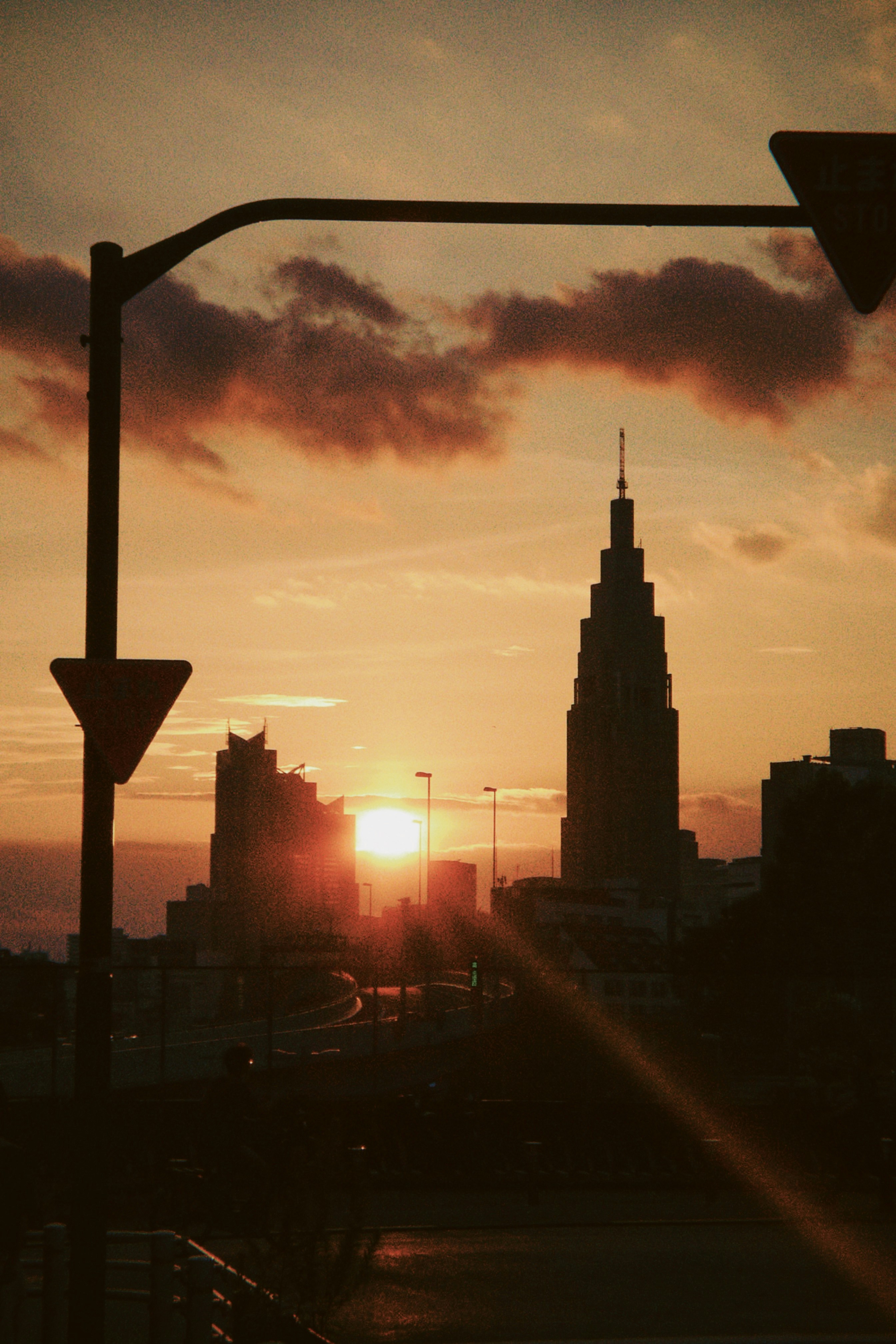 City skyline at sunset with dramatic clouds
