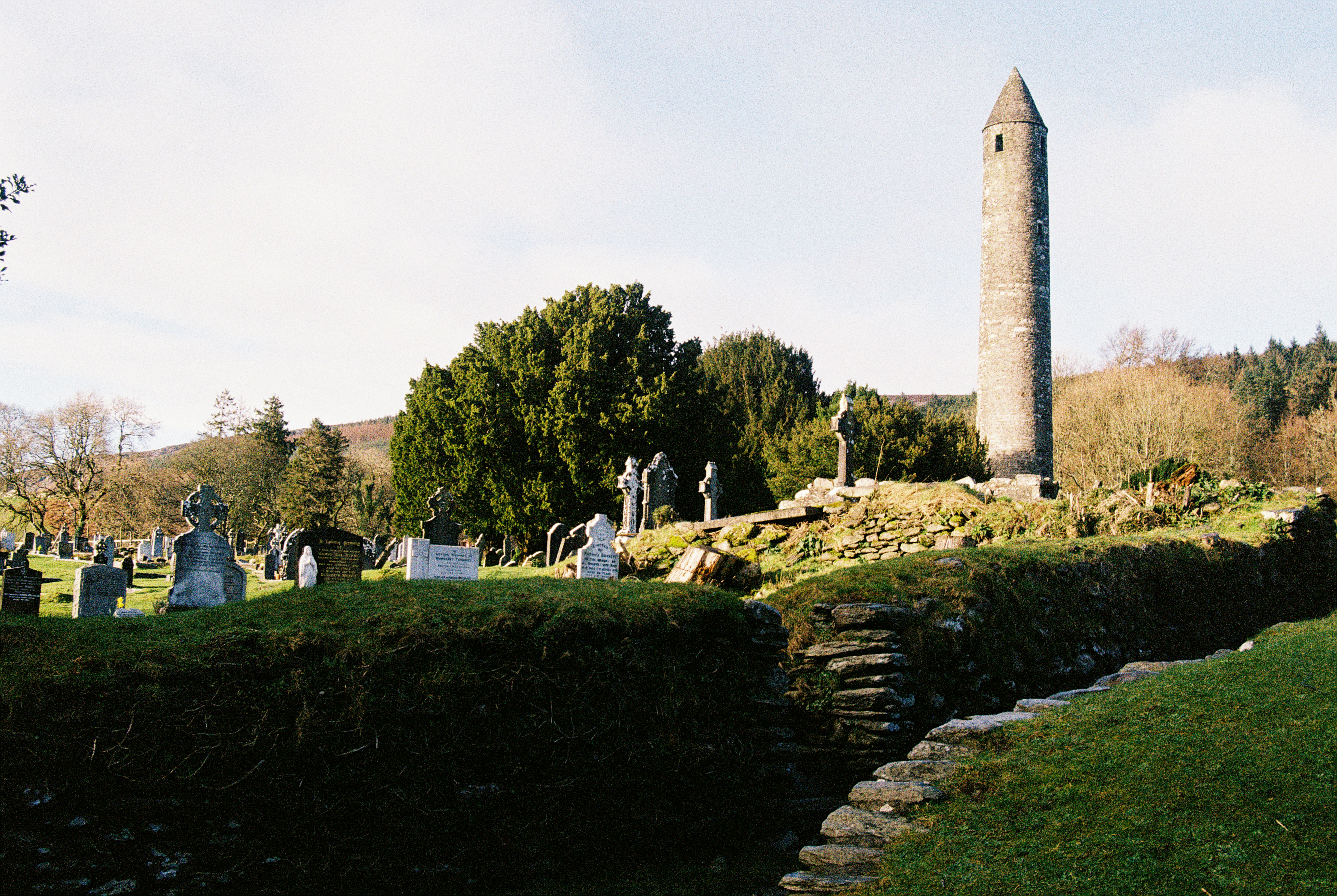 Round tower and gravestones in a historic cemetery
