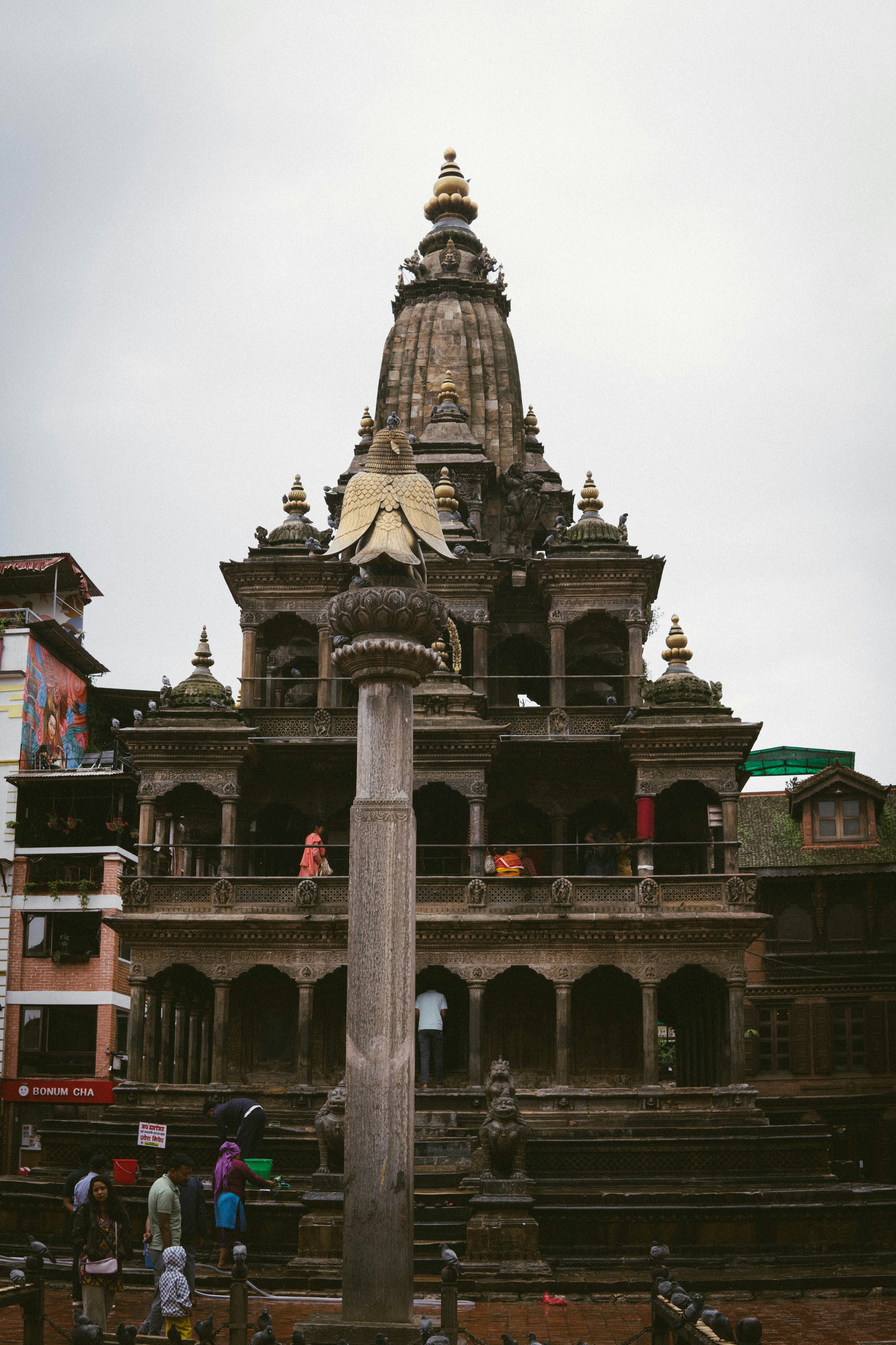Ornate stone temple with tiered roof and pillars
