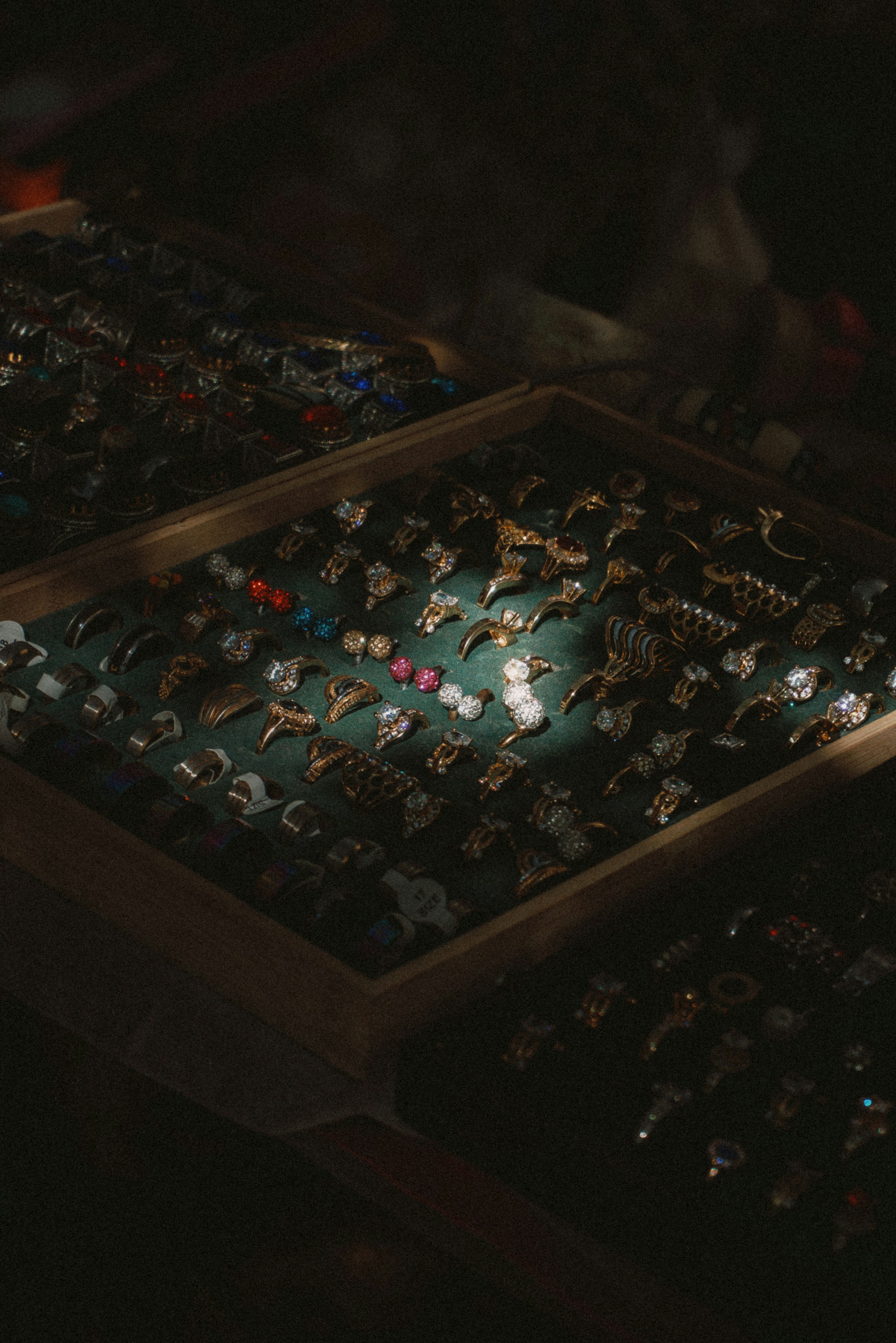 Boxhagenerplatz thrift market in Berlin. | Assortment of antique rings displayed in a wooden box.