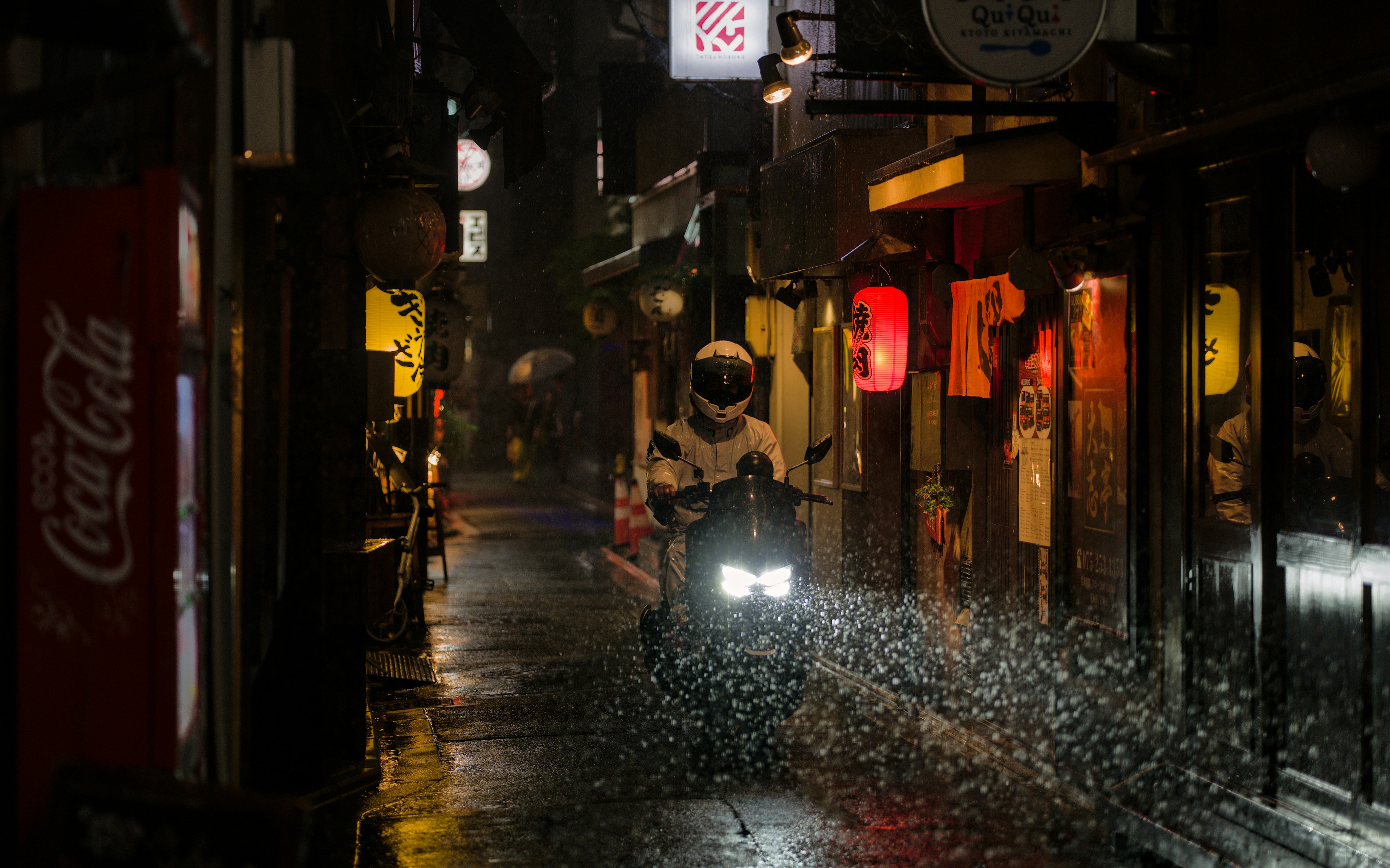 2025-06-10 | Motorcyclist rides through a wet, neon-lit alleyway at night