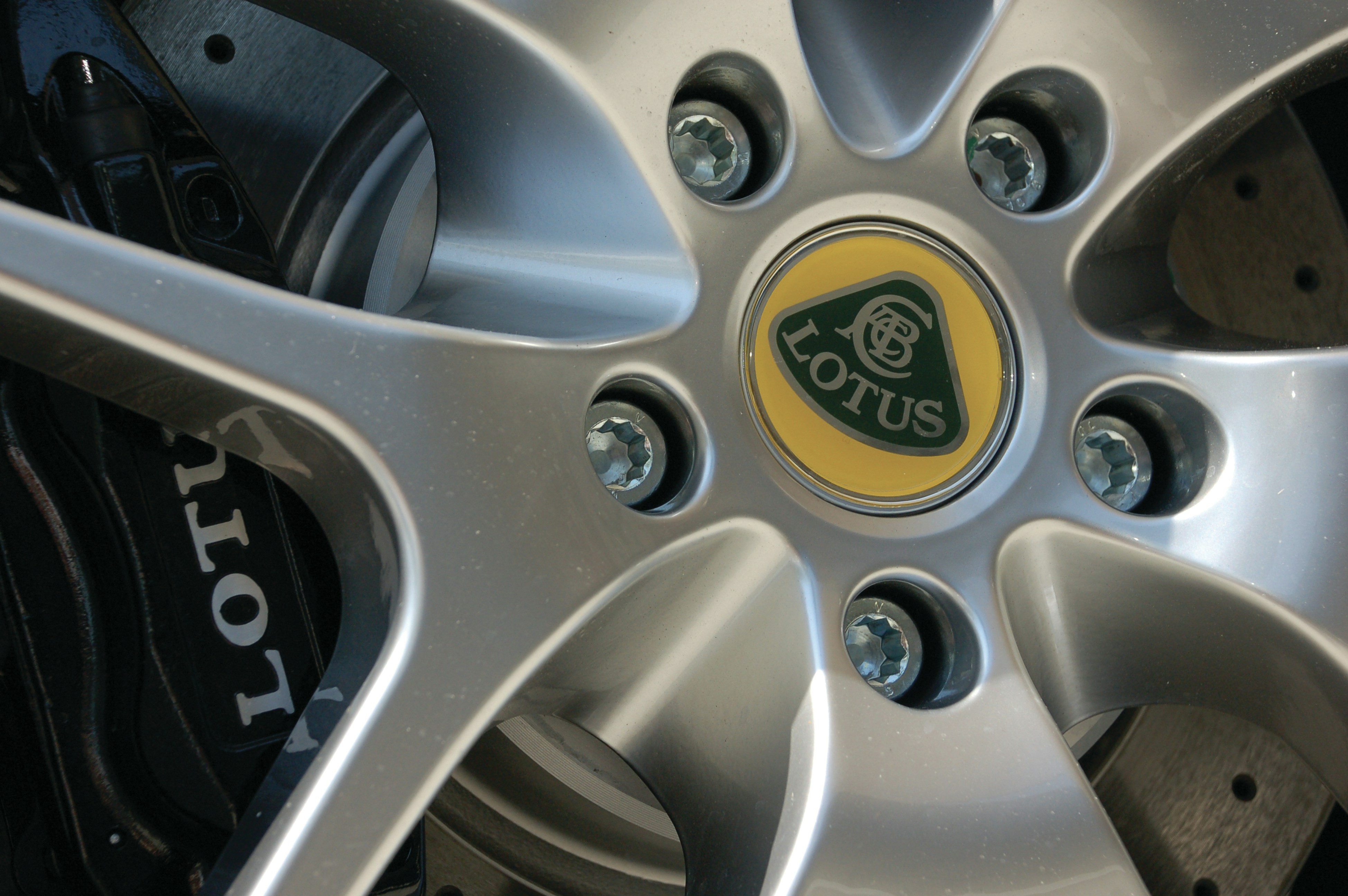 Close-up of a silver lotus car wheel and brake. photo – Free Lotus ...