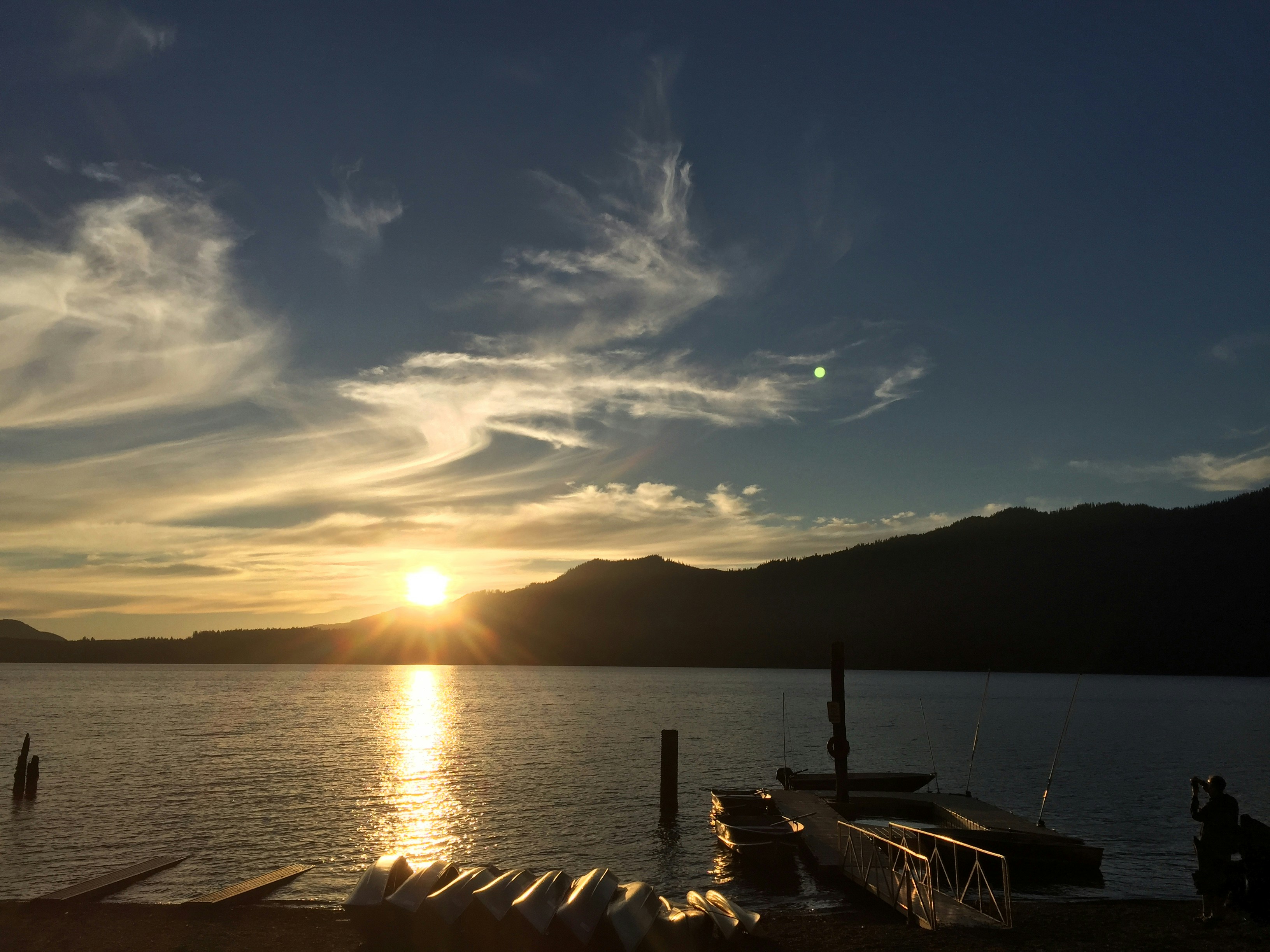 Sunset over a calm lake with mountains