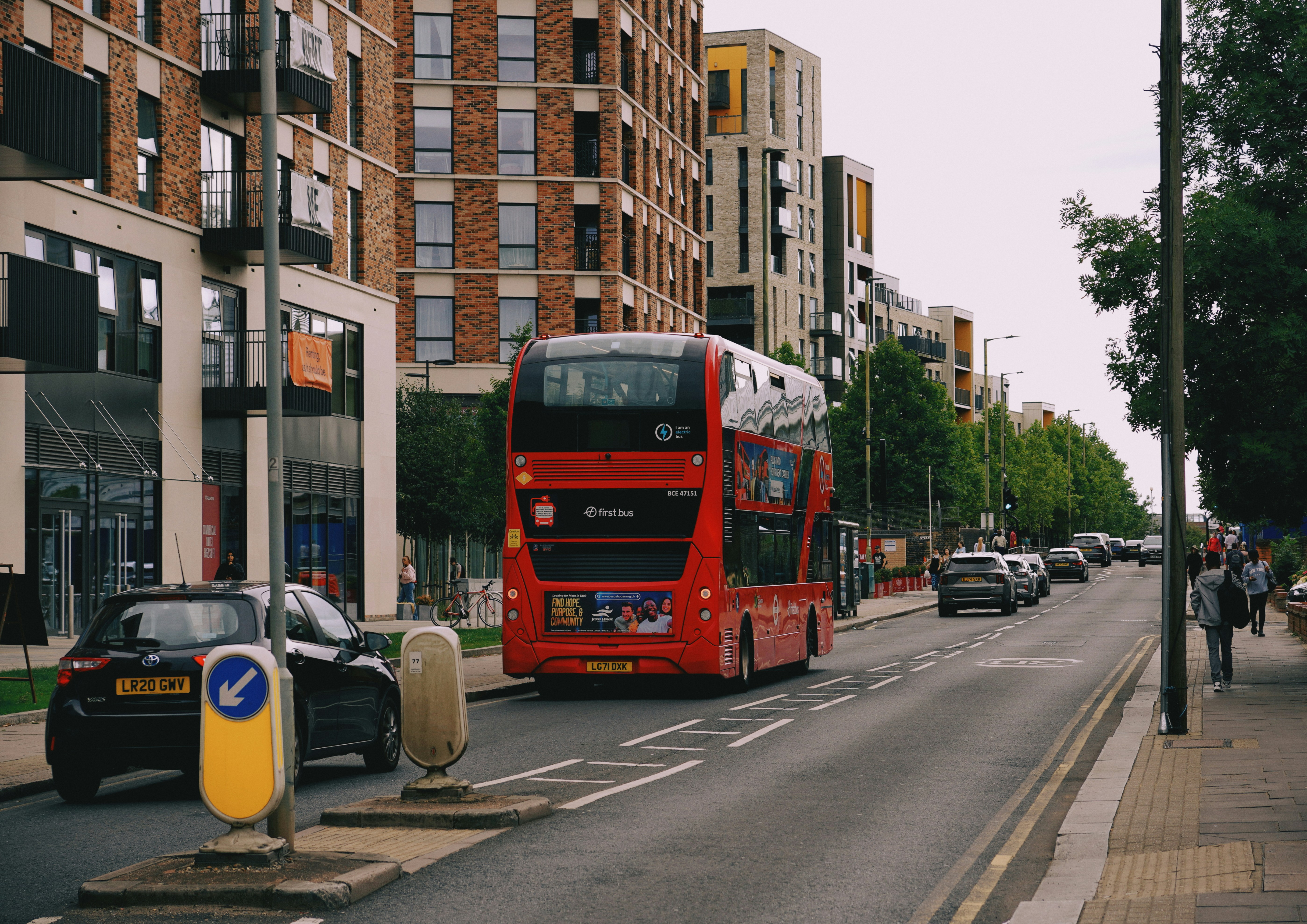 A random double-decker bus in London, Zone 4 | Red double-decker bus driving on a city street