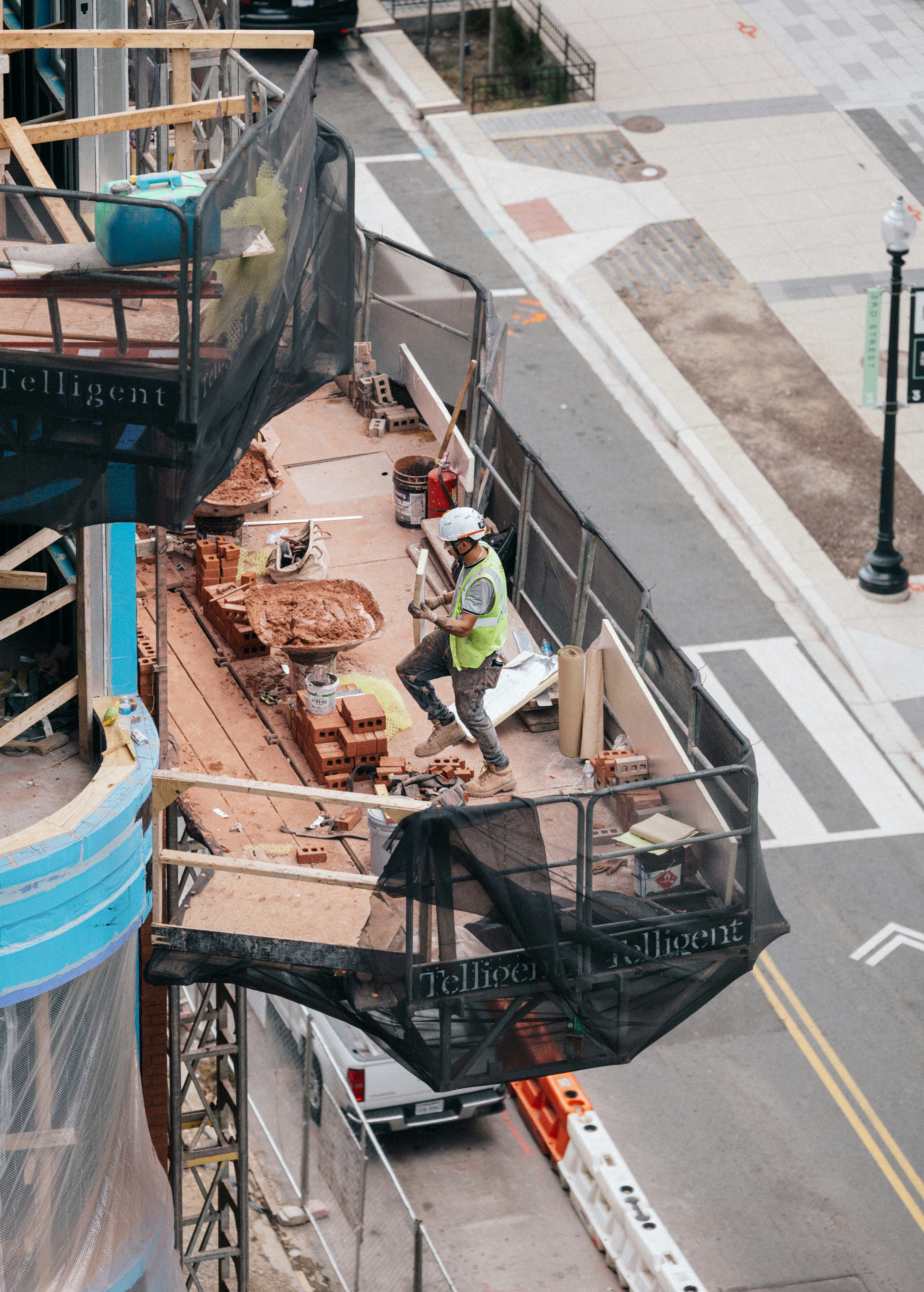 Construction worker on a scaffold with bricks