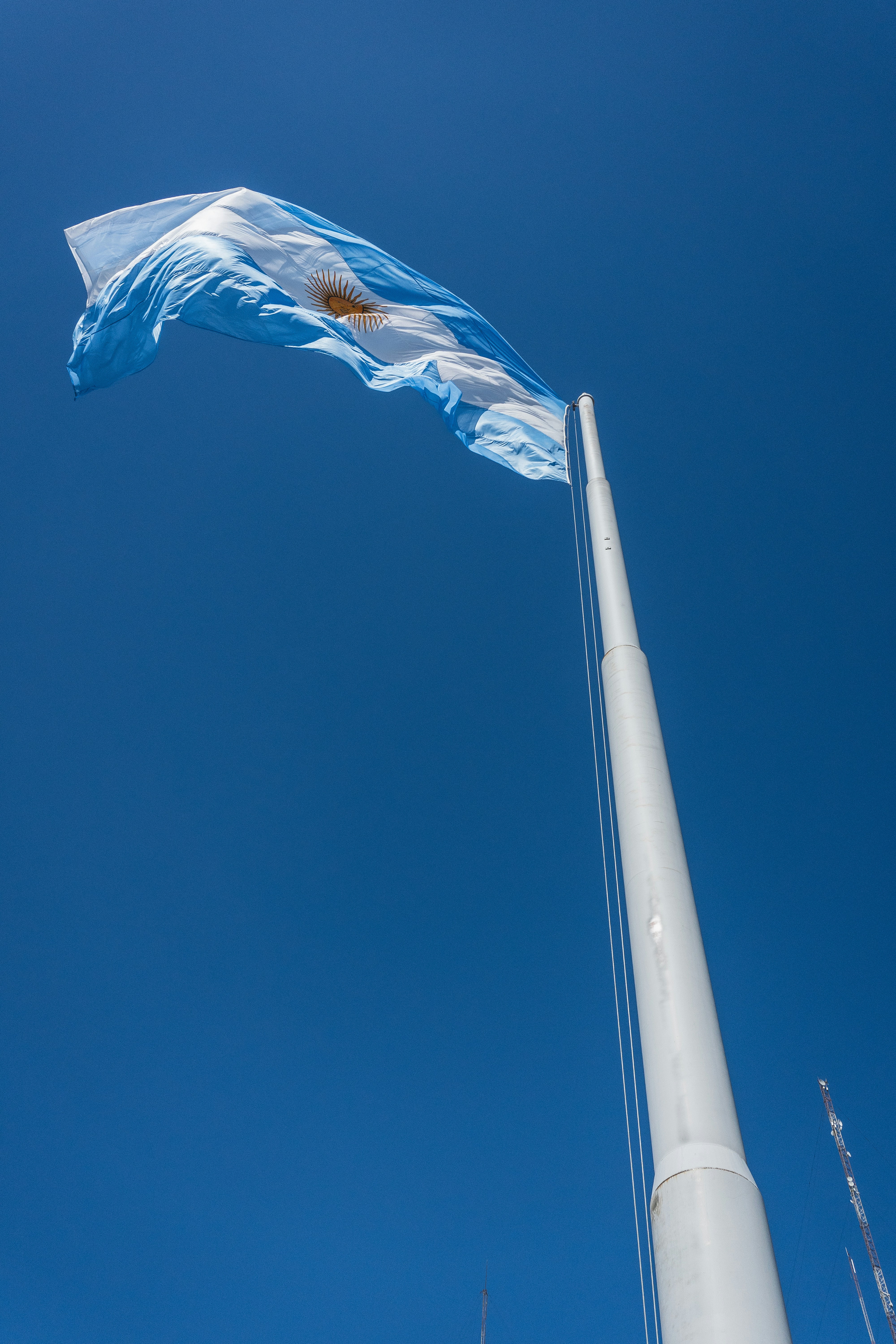 Argentinian flag waving against a clear blue sky