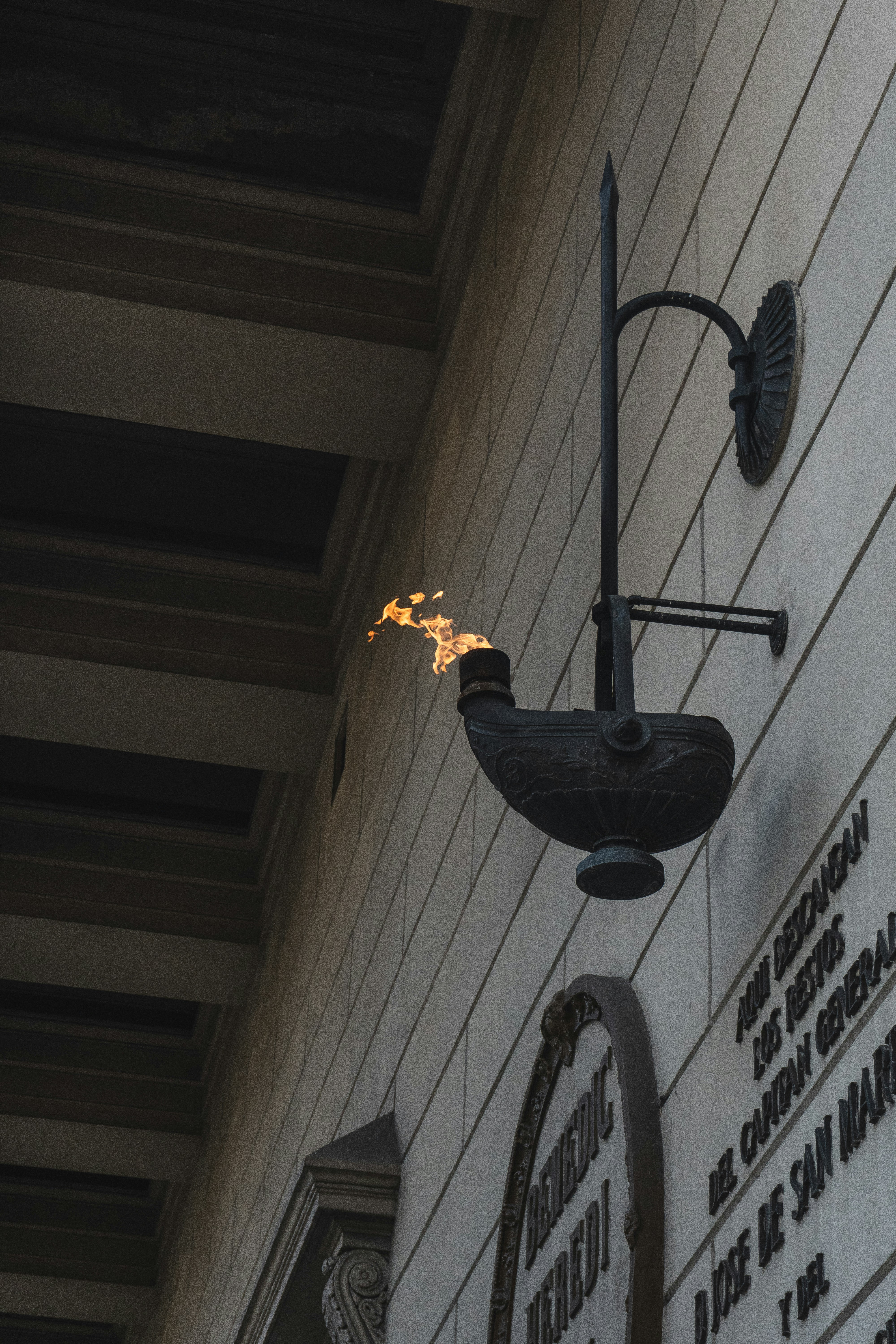 A lit torch mounted on a building