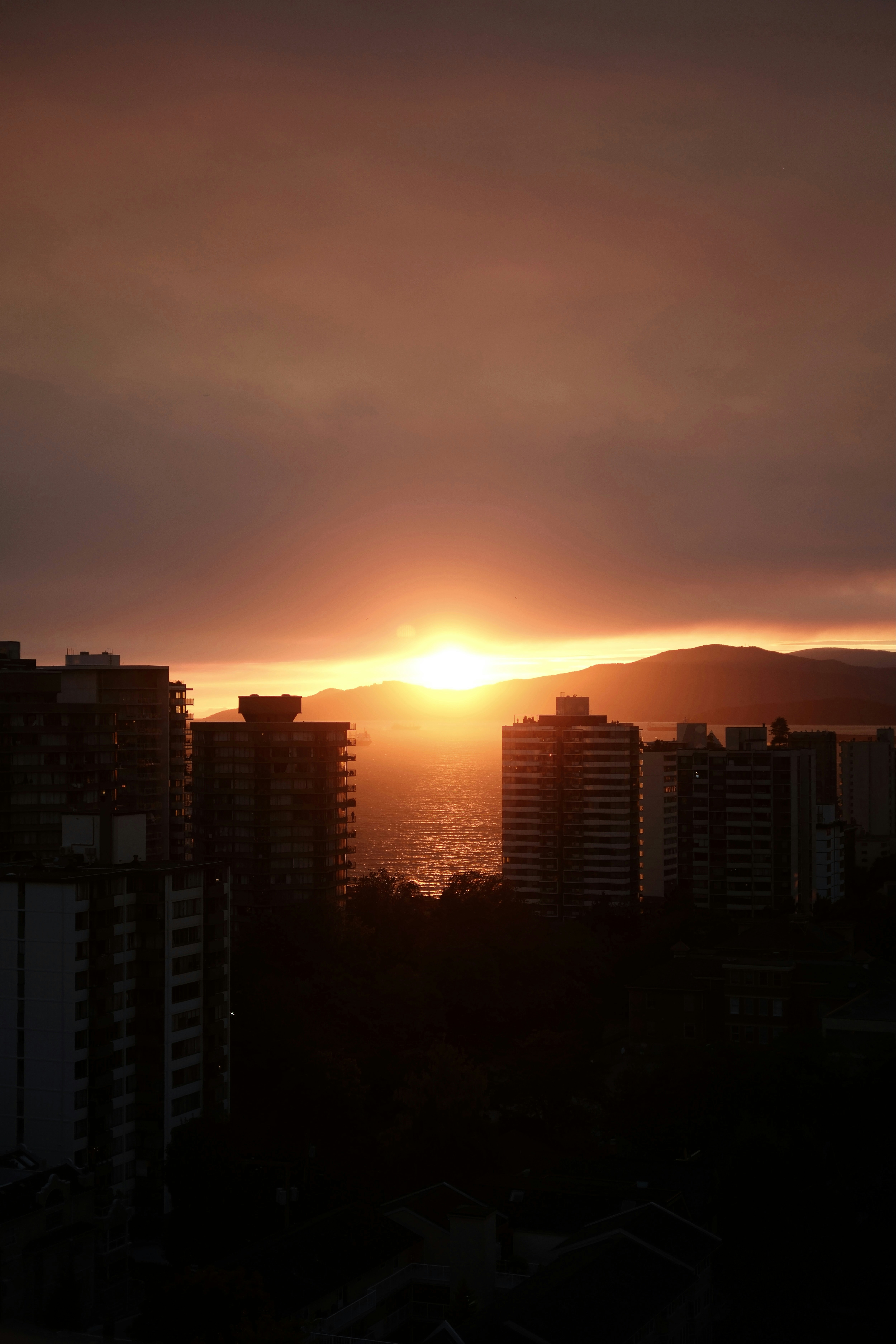 Instagram - @kaprion | Sunset over city skyline and ocean with ocean view of water