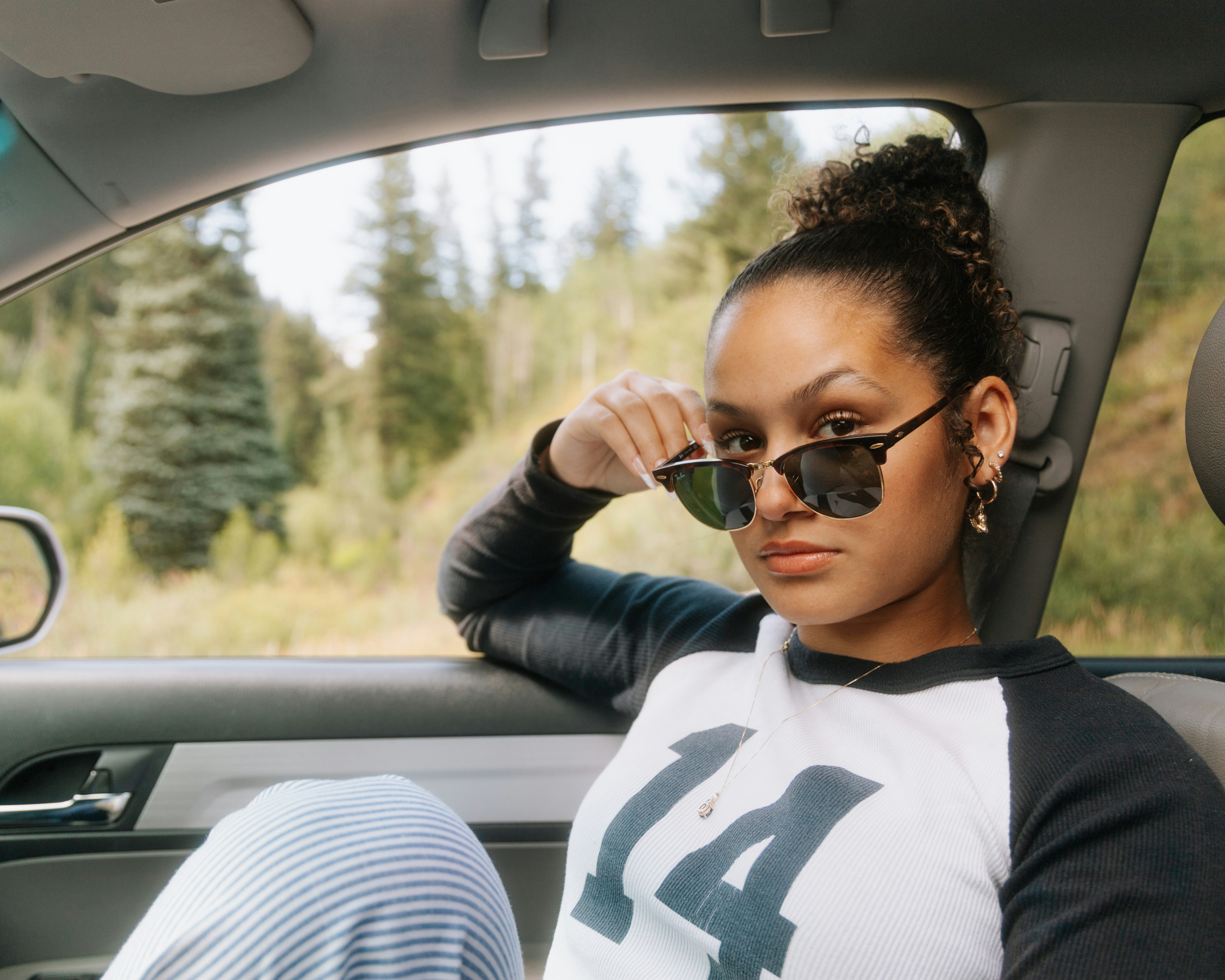 Sunglasses Pause: Casual Confidence in a Car Interior