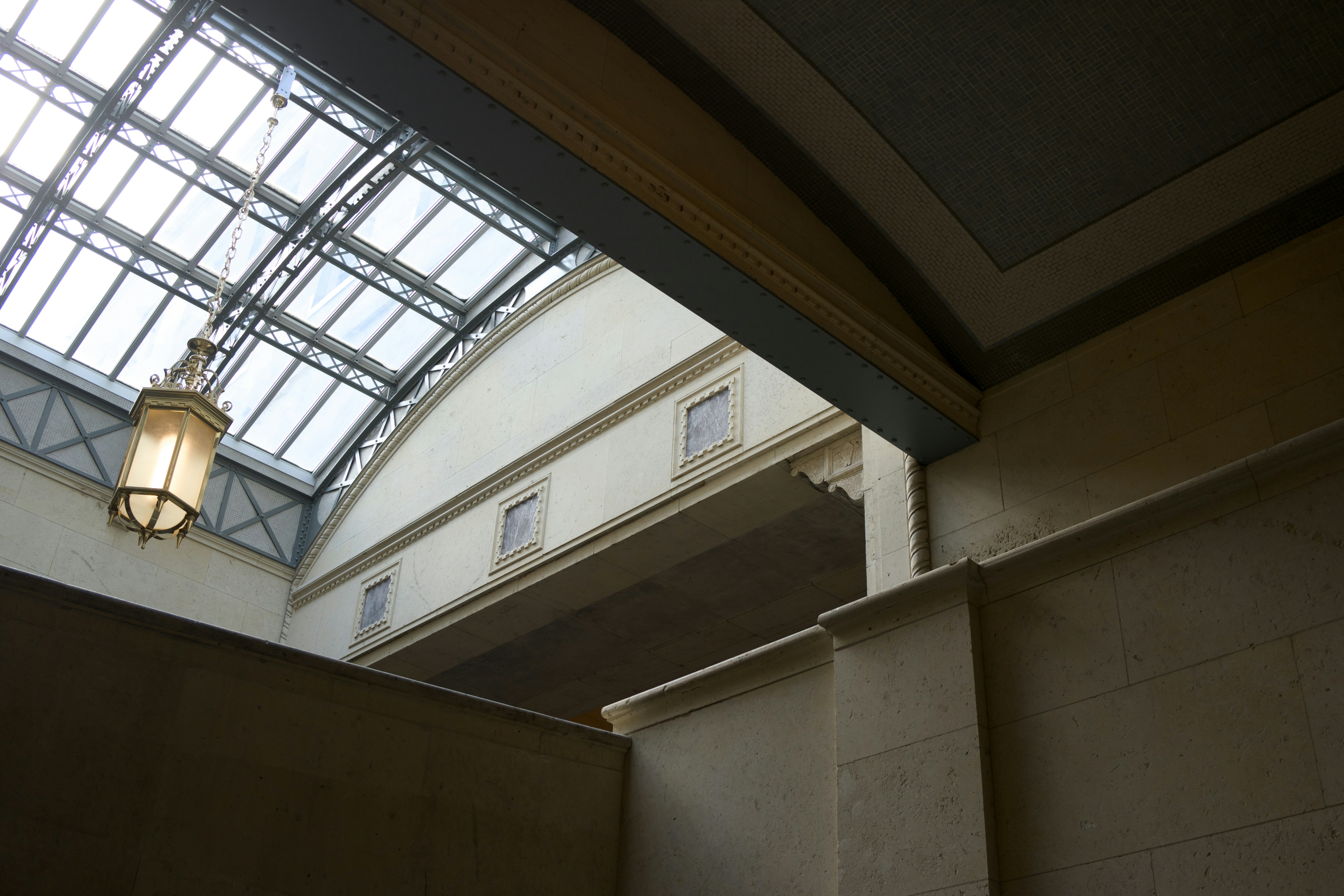 wait. | Interior view of a building with a skylight