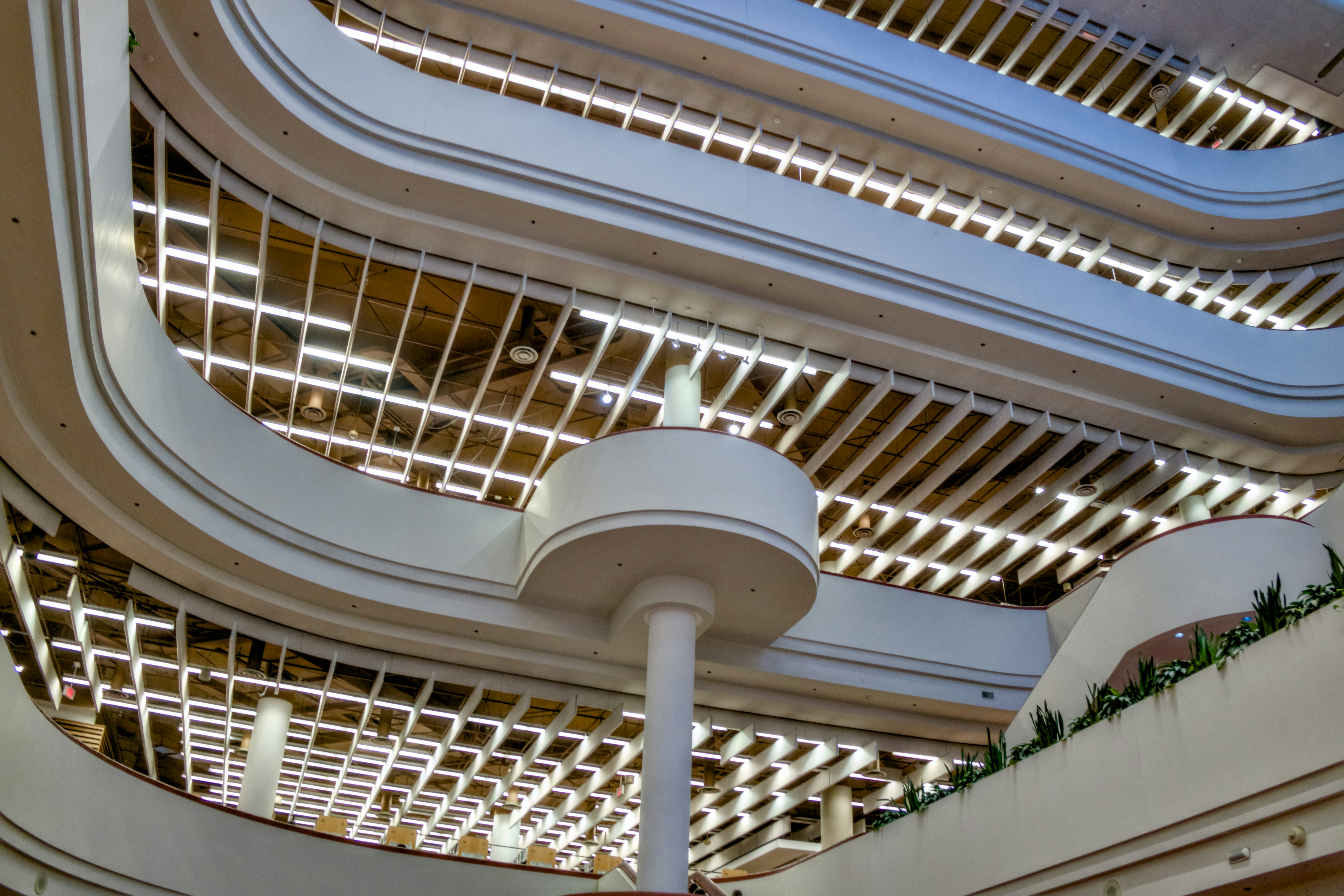 seldom. | Modern building interior with curved balconies and atrium