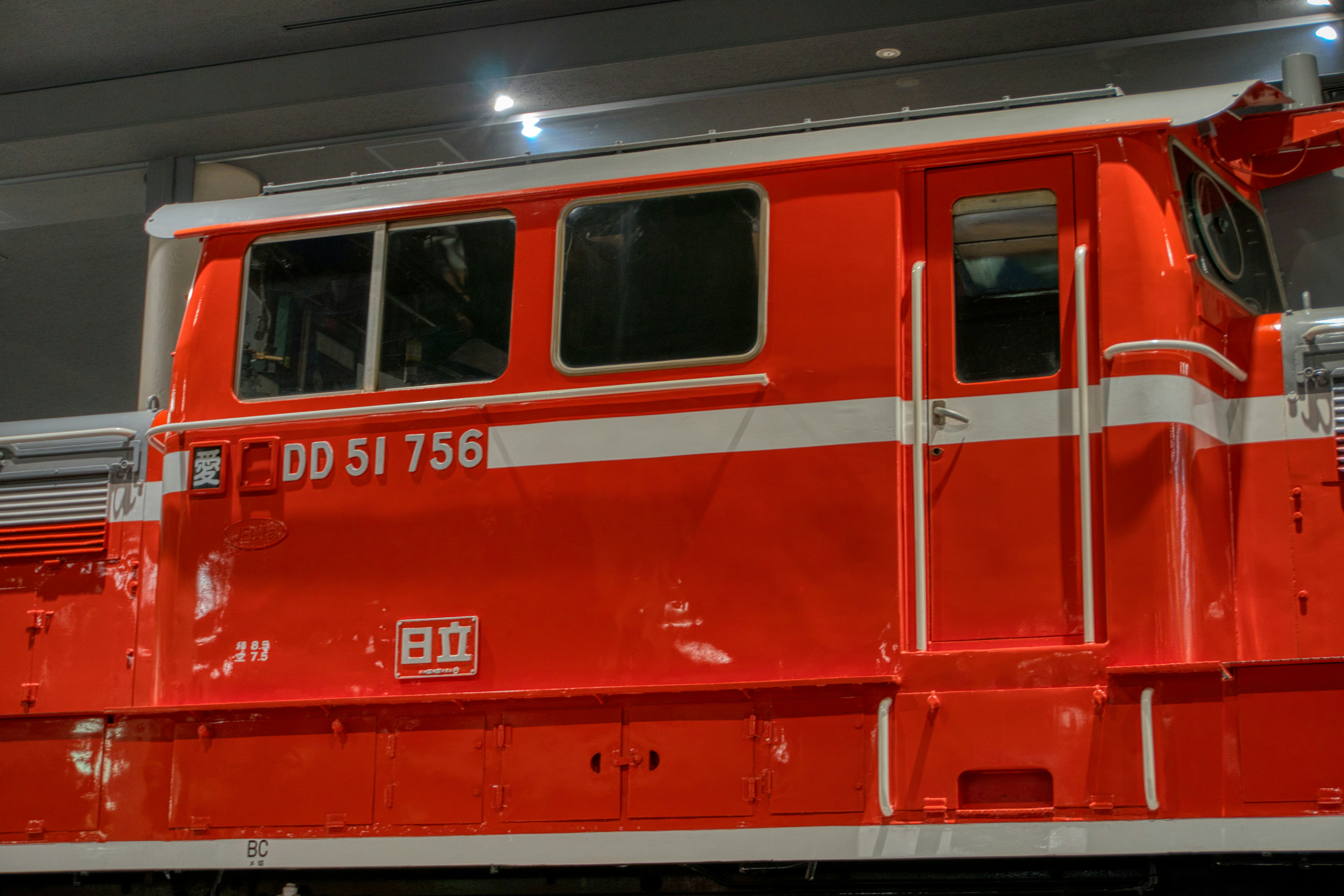 Bright red train engine with white stripes